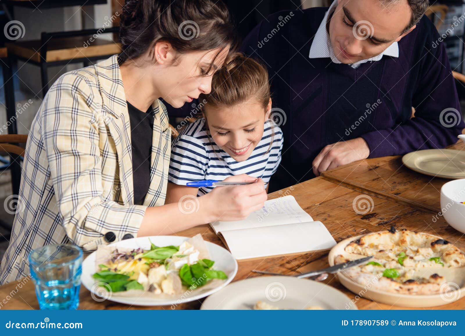 Young Parents Checking Their Daughter`s Homework. There are a Few ...