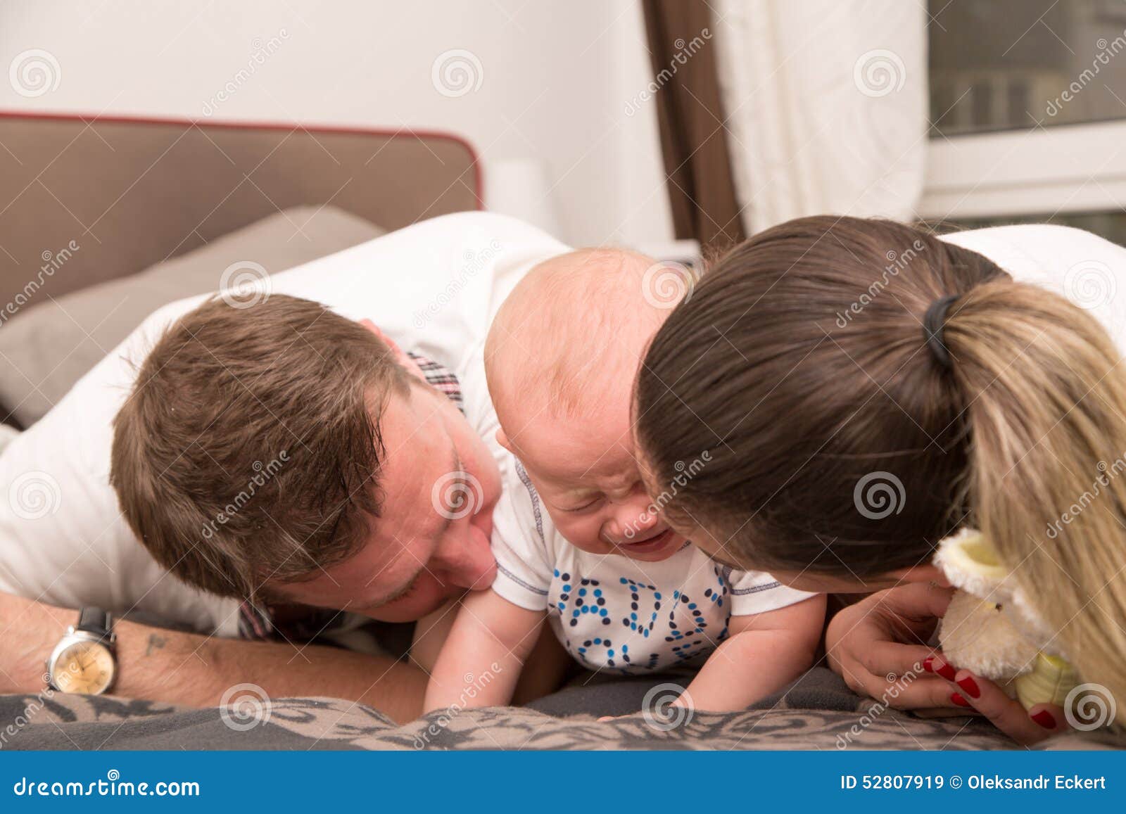 Young Parents Comfort Her Crying Baby Stock Image - Image of portrait ...