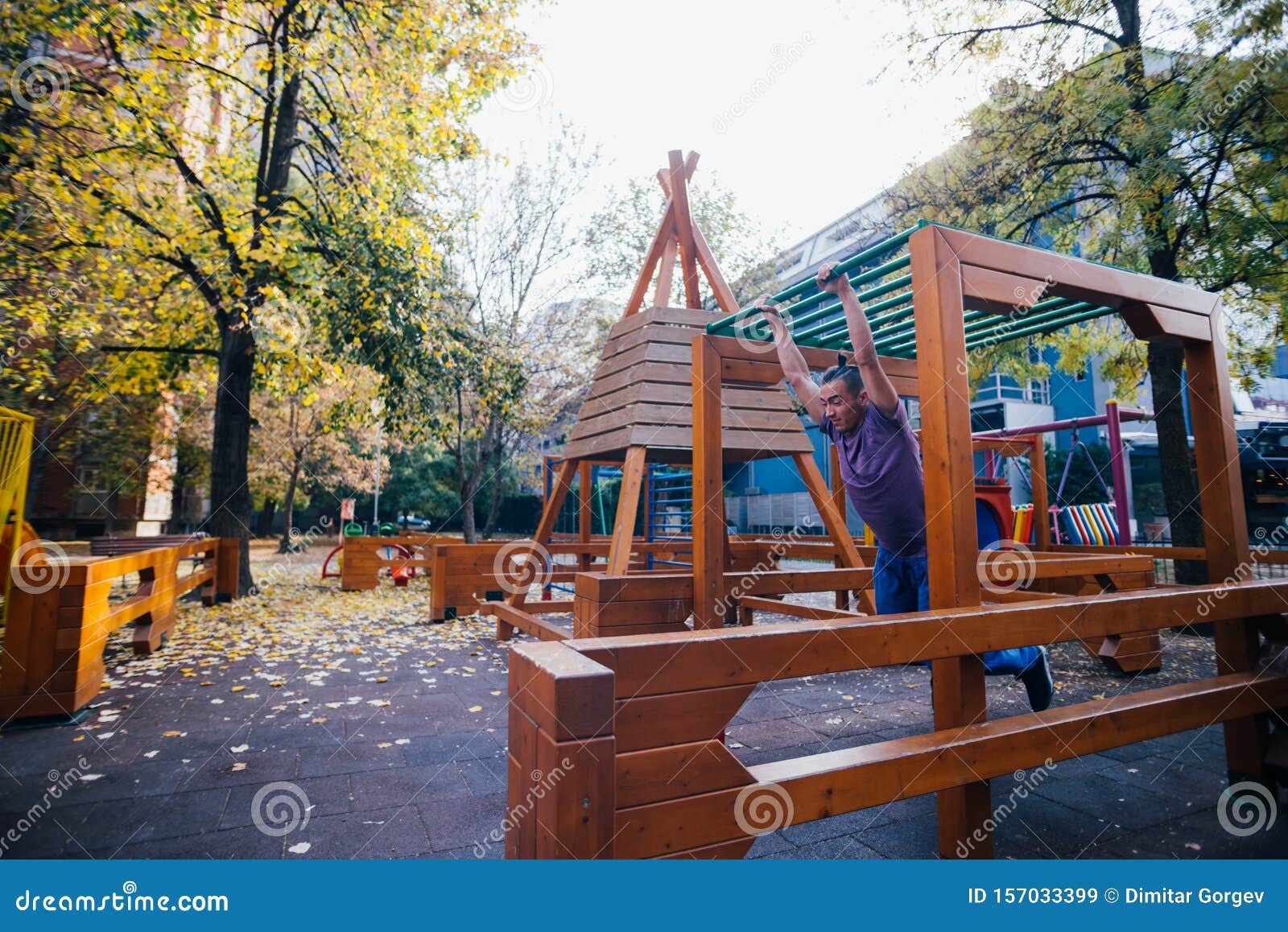 Young Parkour Guy Doing Tricks, Flips and Exercising at a Playground ...