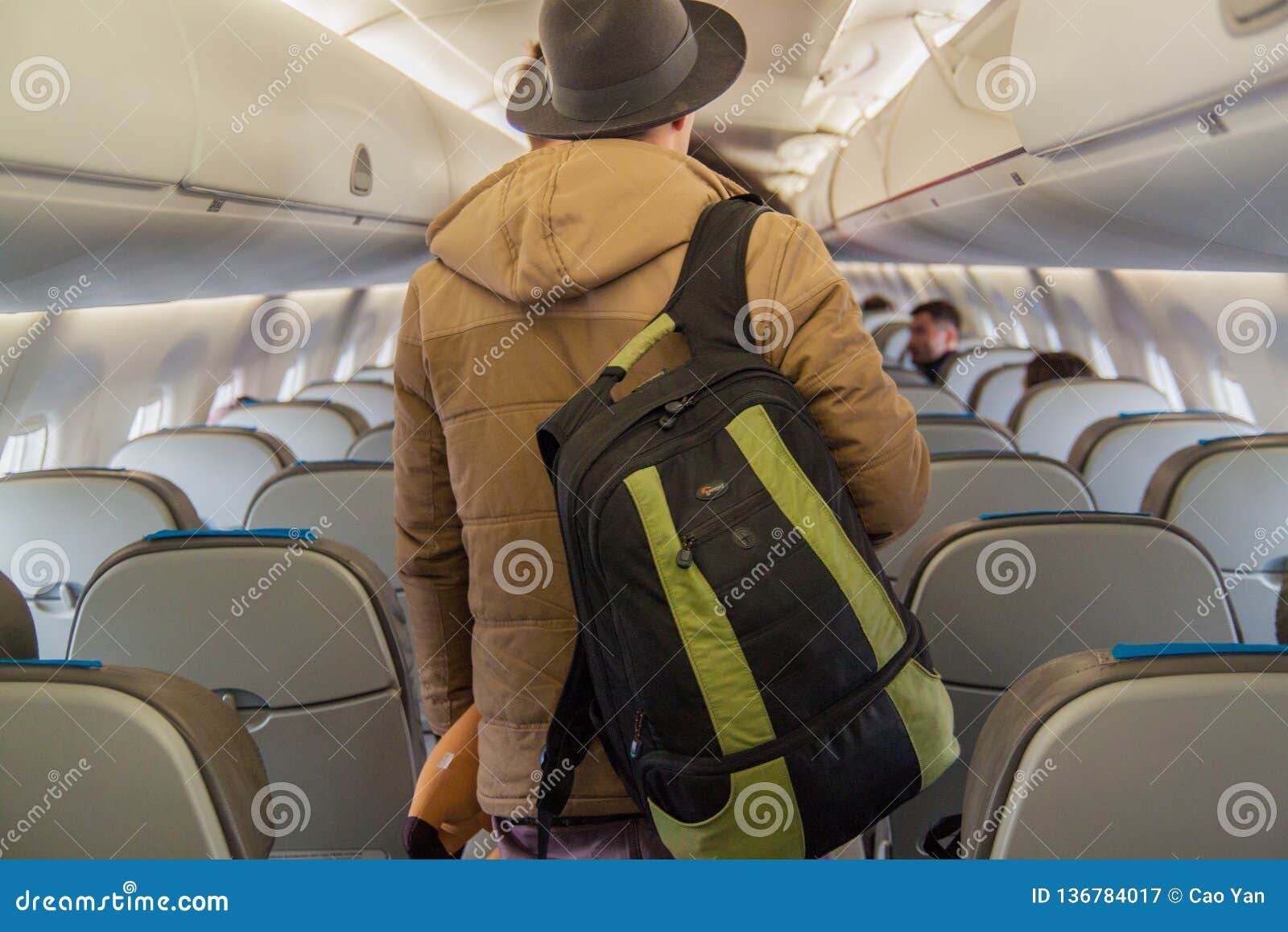 Handsome Young Passenger in a Warm Jacket and Hat Stands with a ...