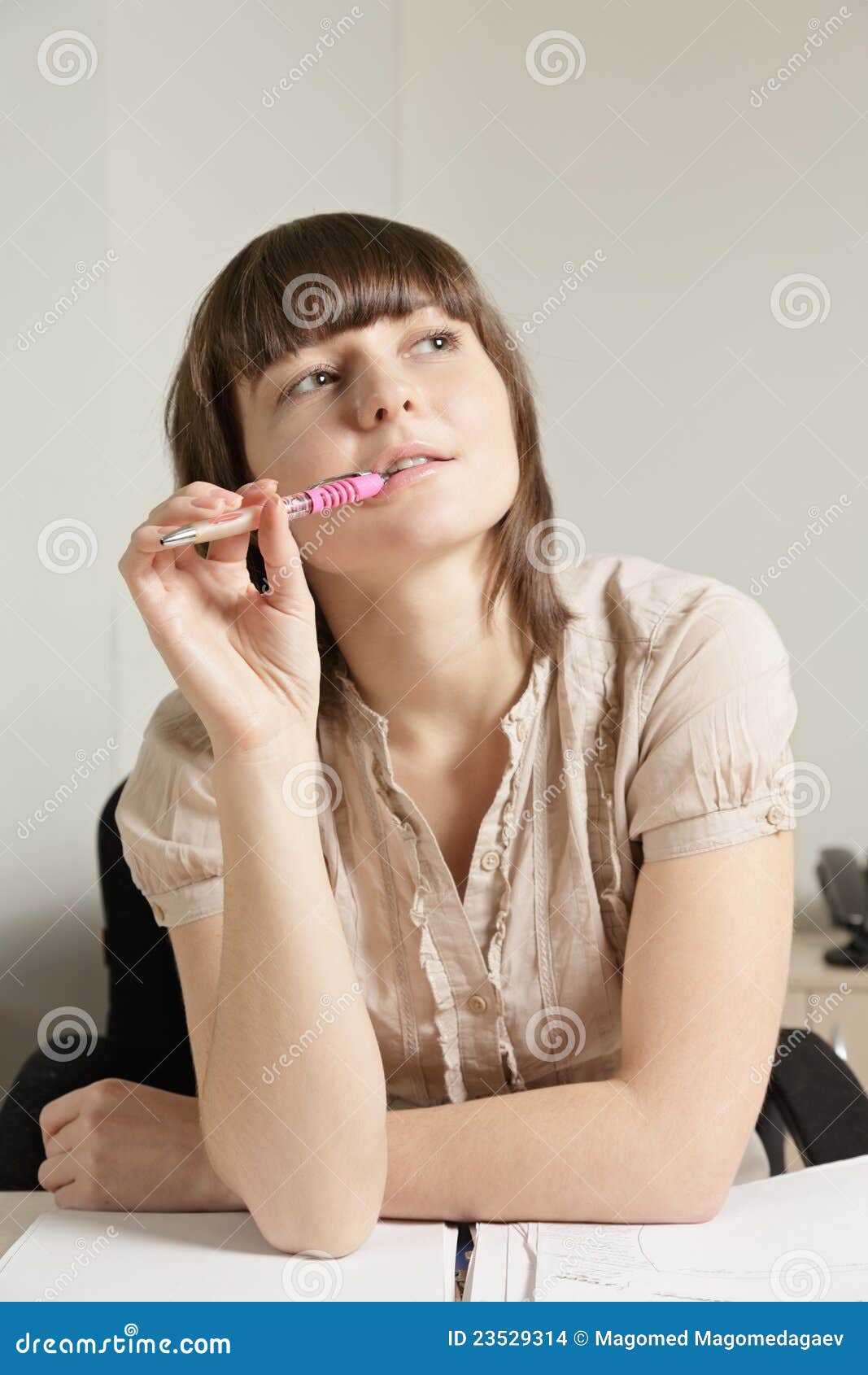 Young Pensive Woman Biting Pen Stock Photo - Image of pretty, desk ...