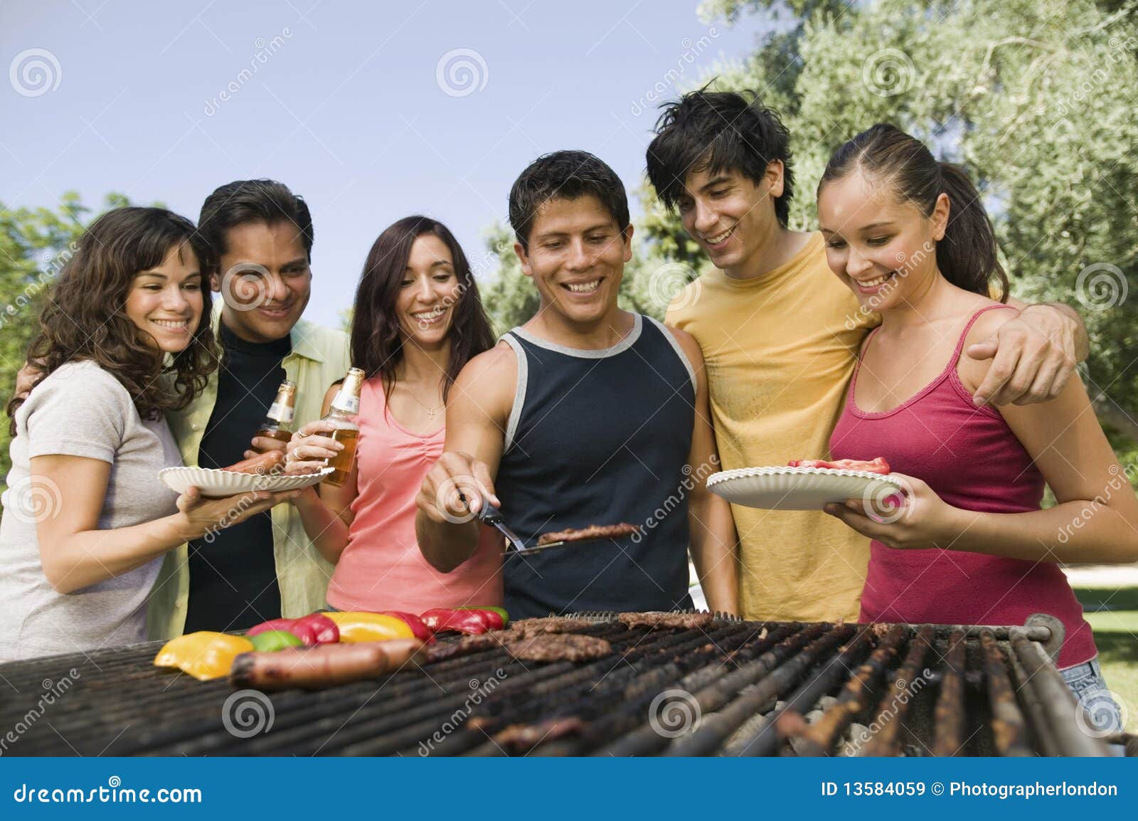 Young people around grill. stock image. Image of friendship - 13584059