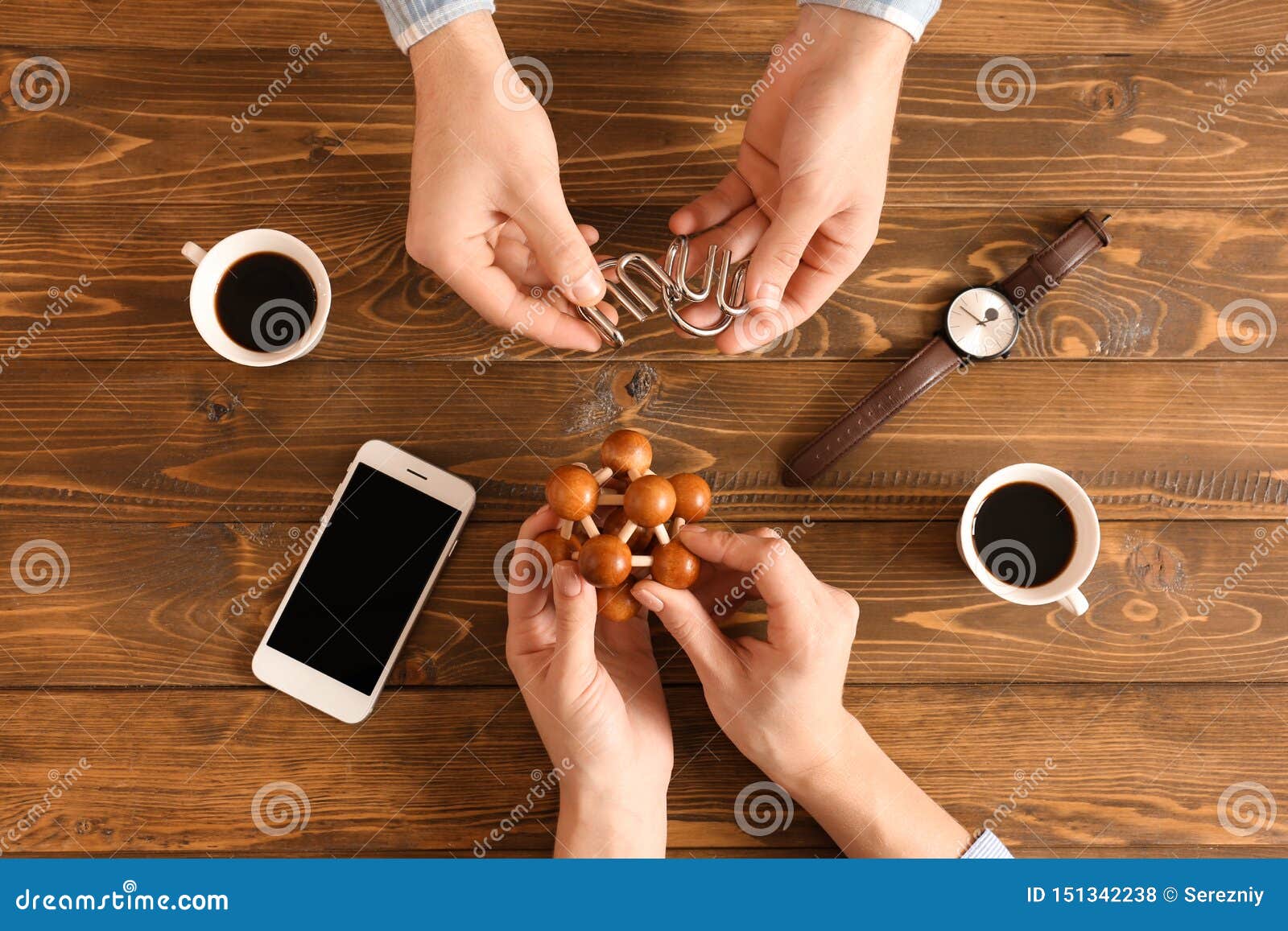Young People with Brain Teasers at Wooden Table Stock Photo - Image of ...