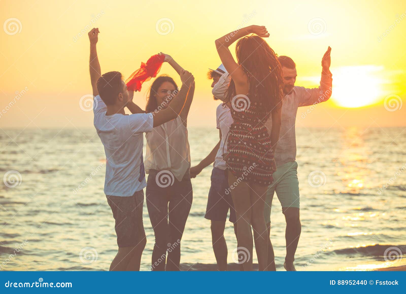 Young People Dancing on Beach at Sunset Stock Photo - Image of outdoors ...