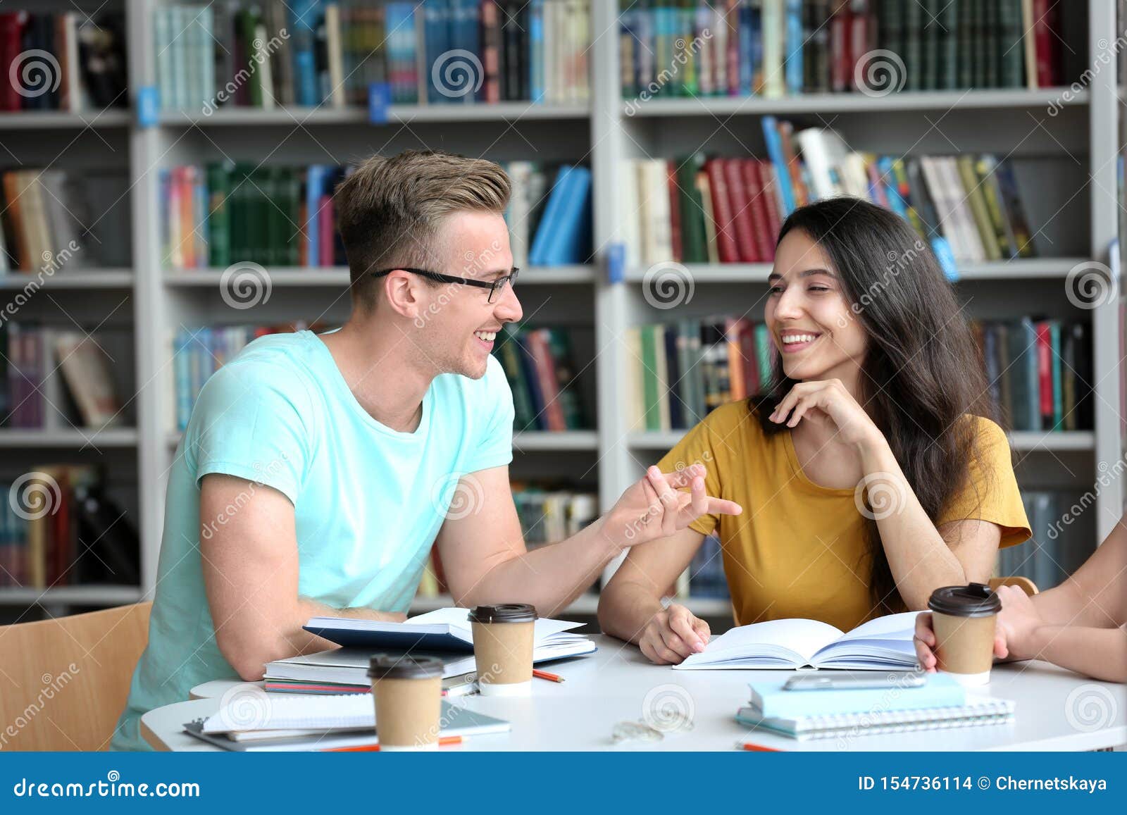 Young People Discussing Group Project at Table Stock Photo - Image of ...