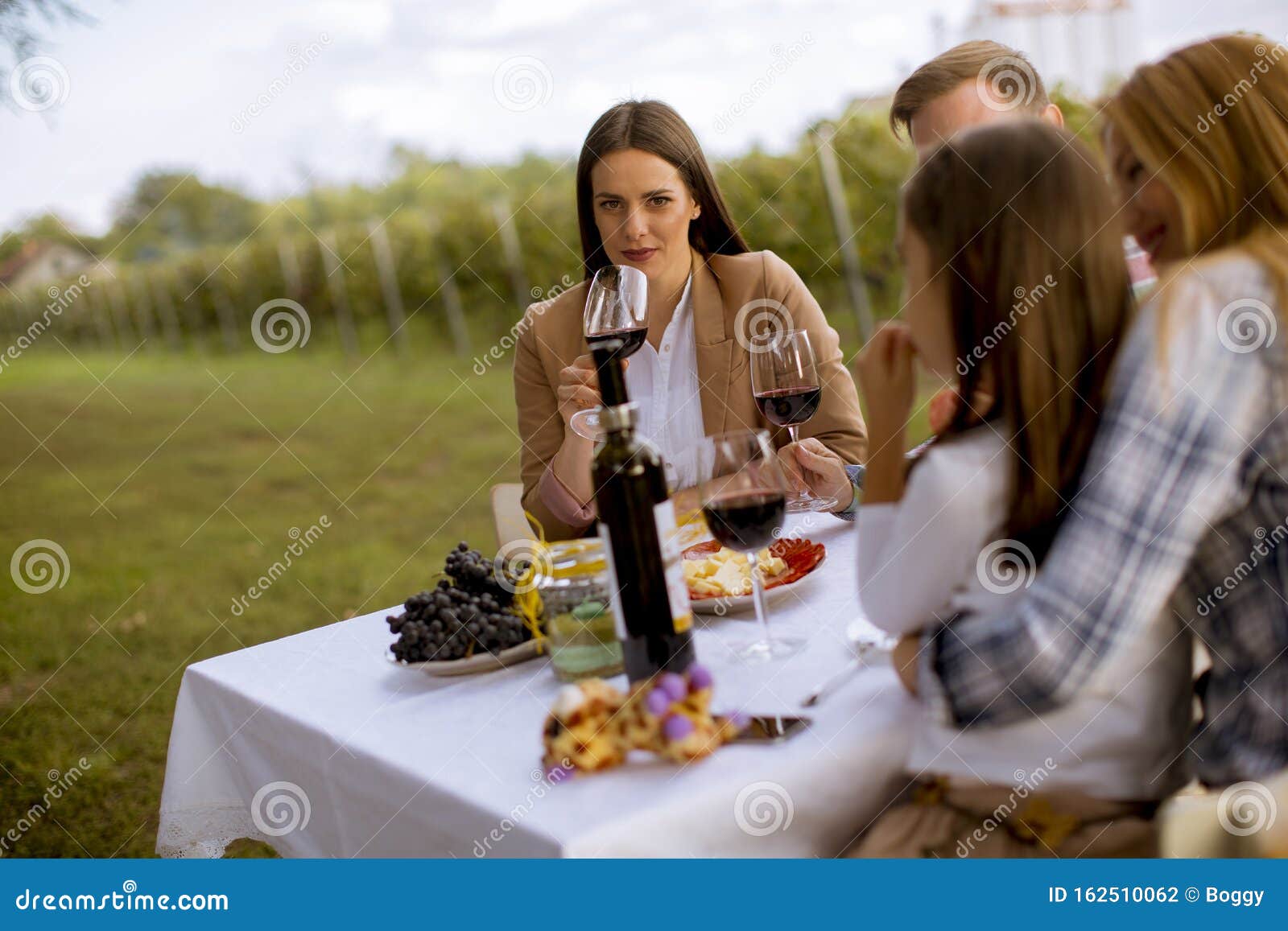 Young People Enjoy Dinner and Wine Tasting in the Vineyard Stock Photo ...
