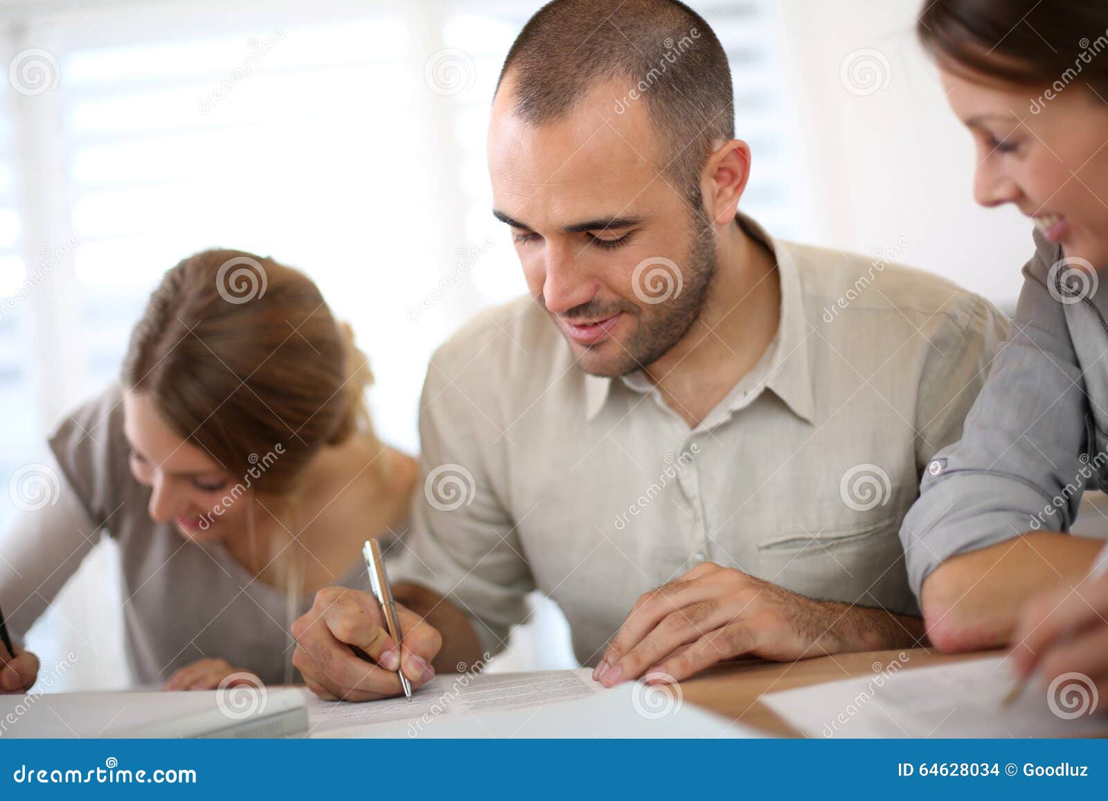 Young People Filling in Forms Stock Photo - Image of students ...