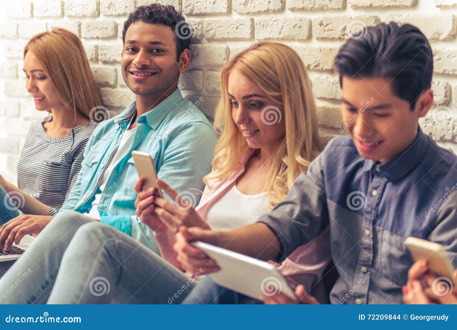 Young people with gadgets stock photo. Image of multiethnic - 72209844