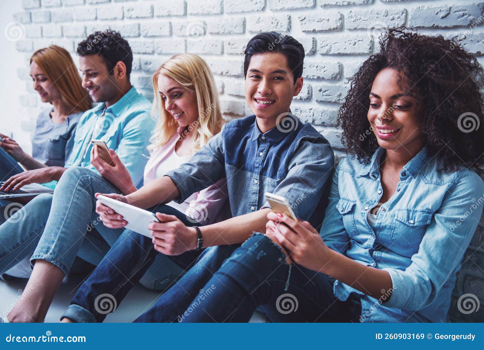 Young people with gadgets stock image. Image of male - 260903169