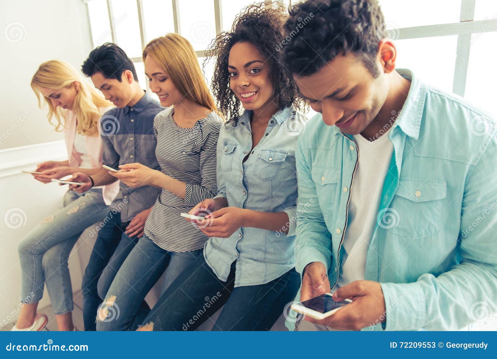 Young people with gadgets stock image. Image of college - 72209553