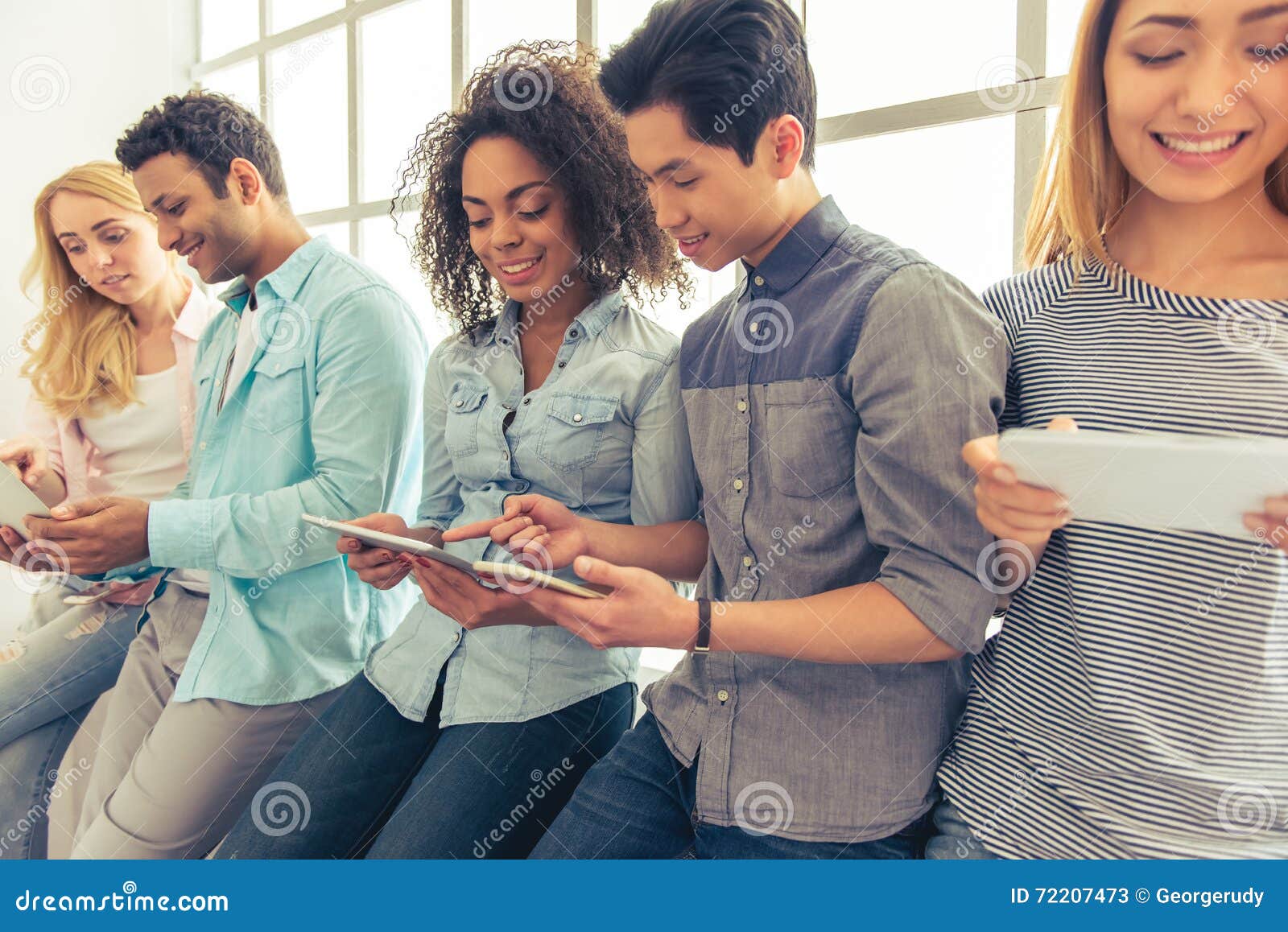 Young people with gadgets stock image. Image of people - 72207473