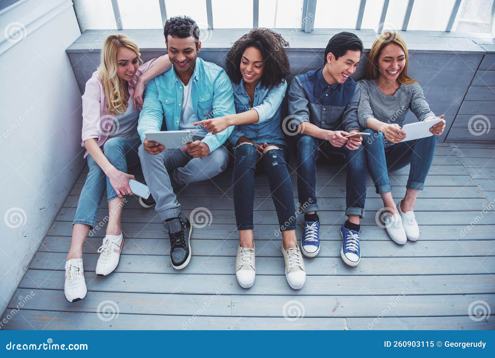 Young people with gadgets stock image. Image of college - 260903115