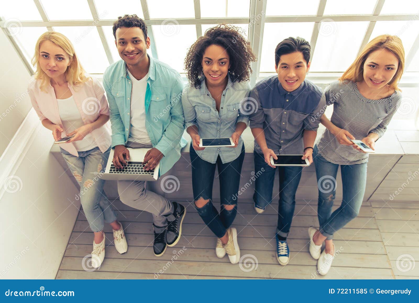 Young people with gadgets stock image. Image of international - 72211585