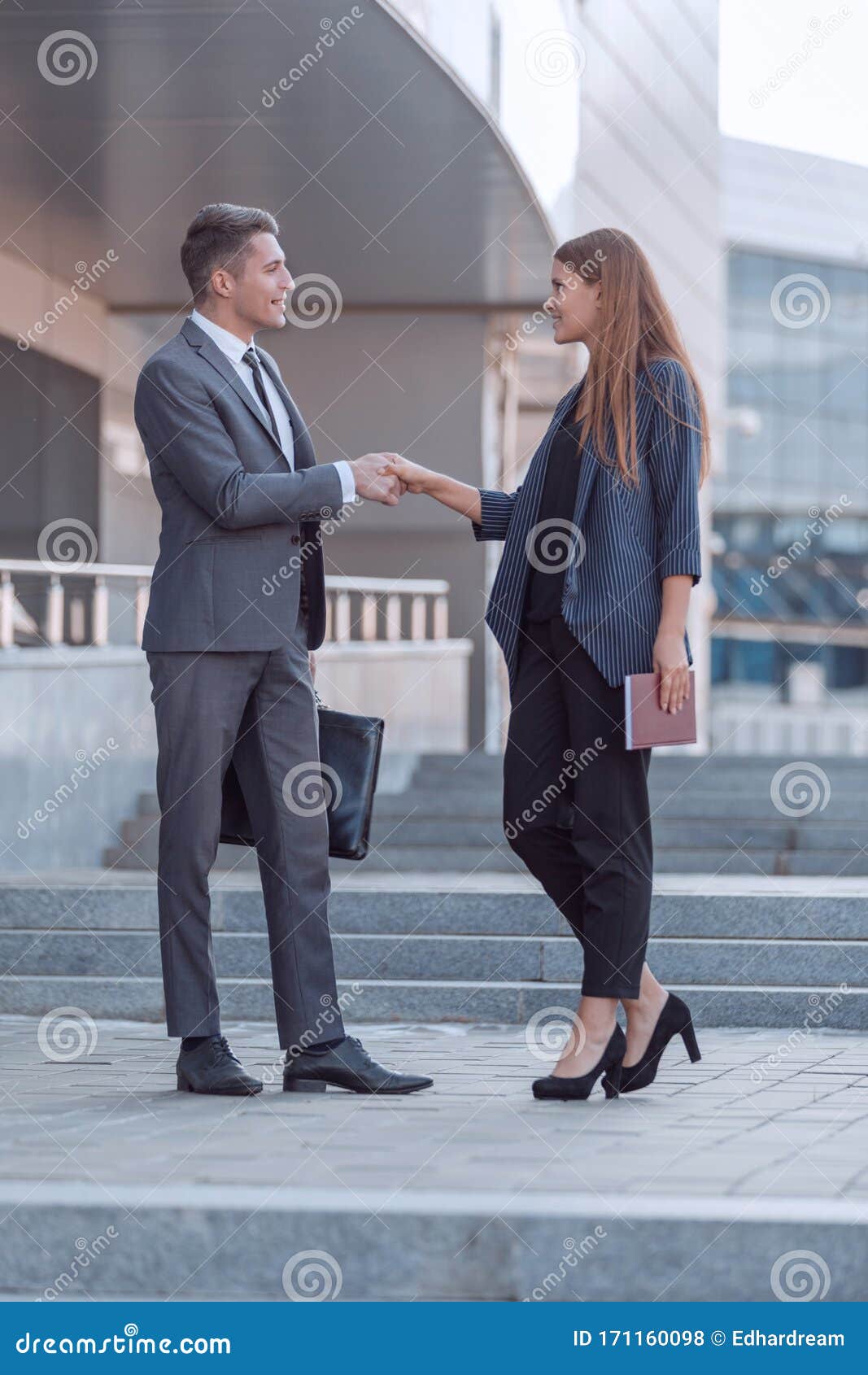 Young People Greeting Each Other in Front of the Office Building Stock ...