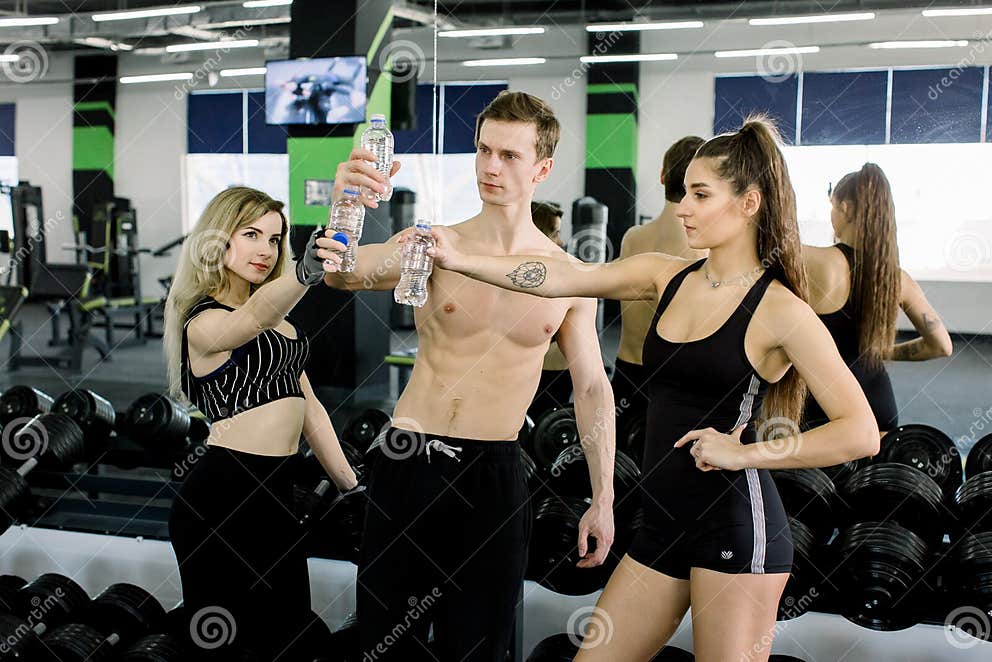 Young People In The Gym Beautiful Young Friends In Sports Clothes