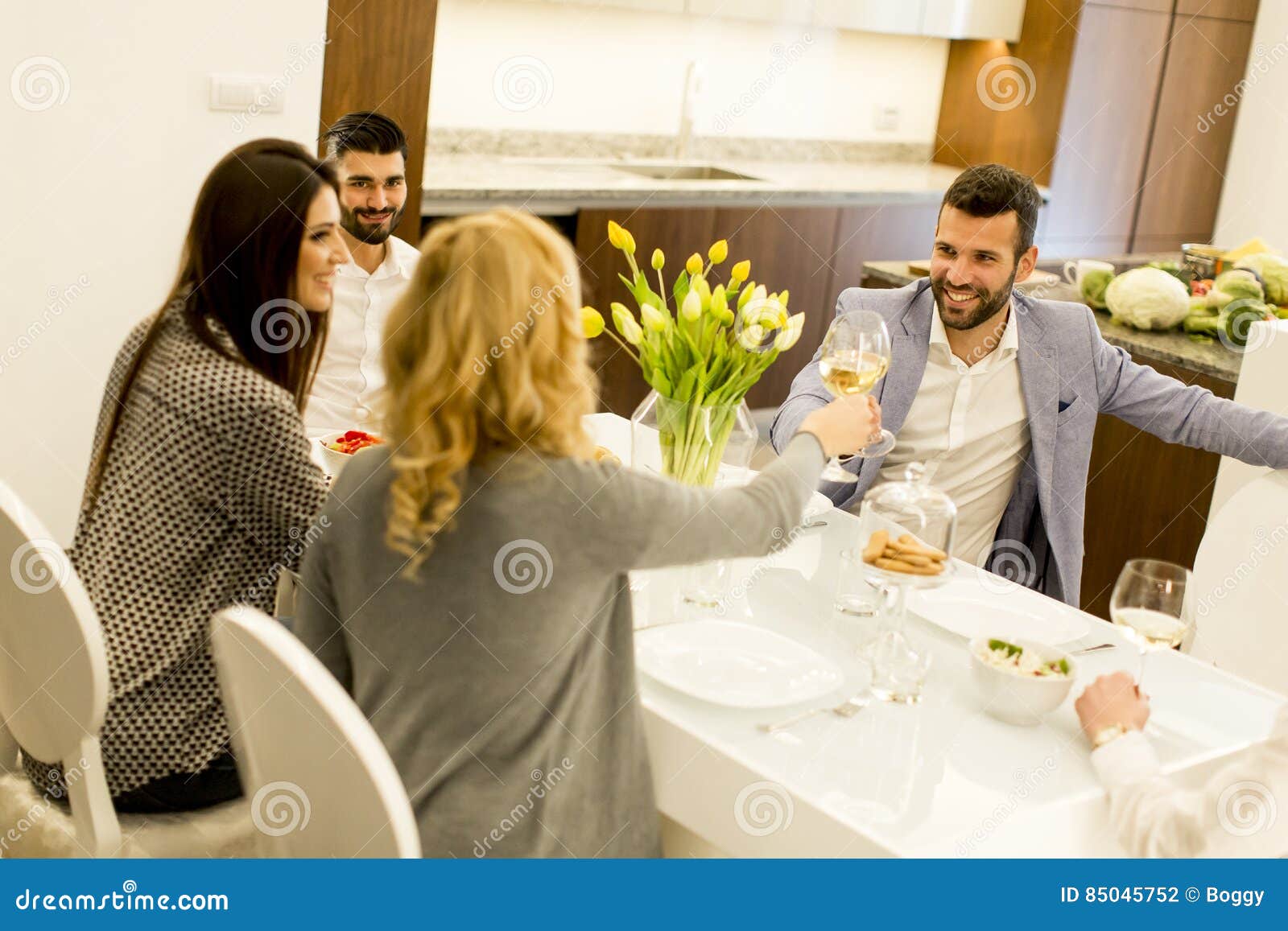 Young people have dinner stock photo. Image of sitting - 85045752
