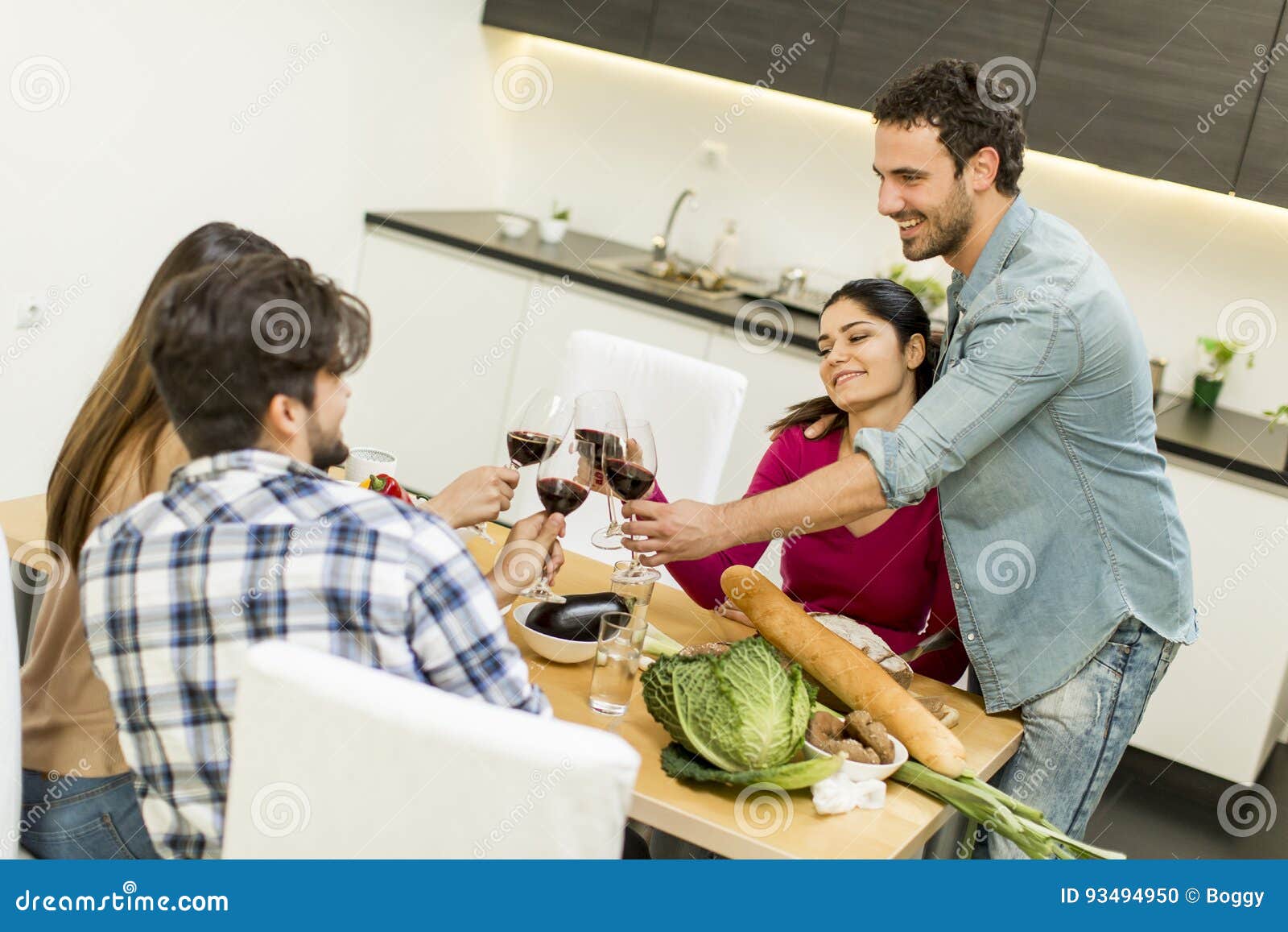 Young People Have a Meal in the Dining Room in Modern Home Stock Photo ...