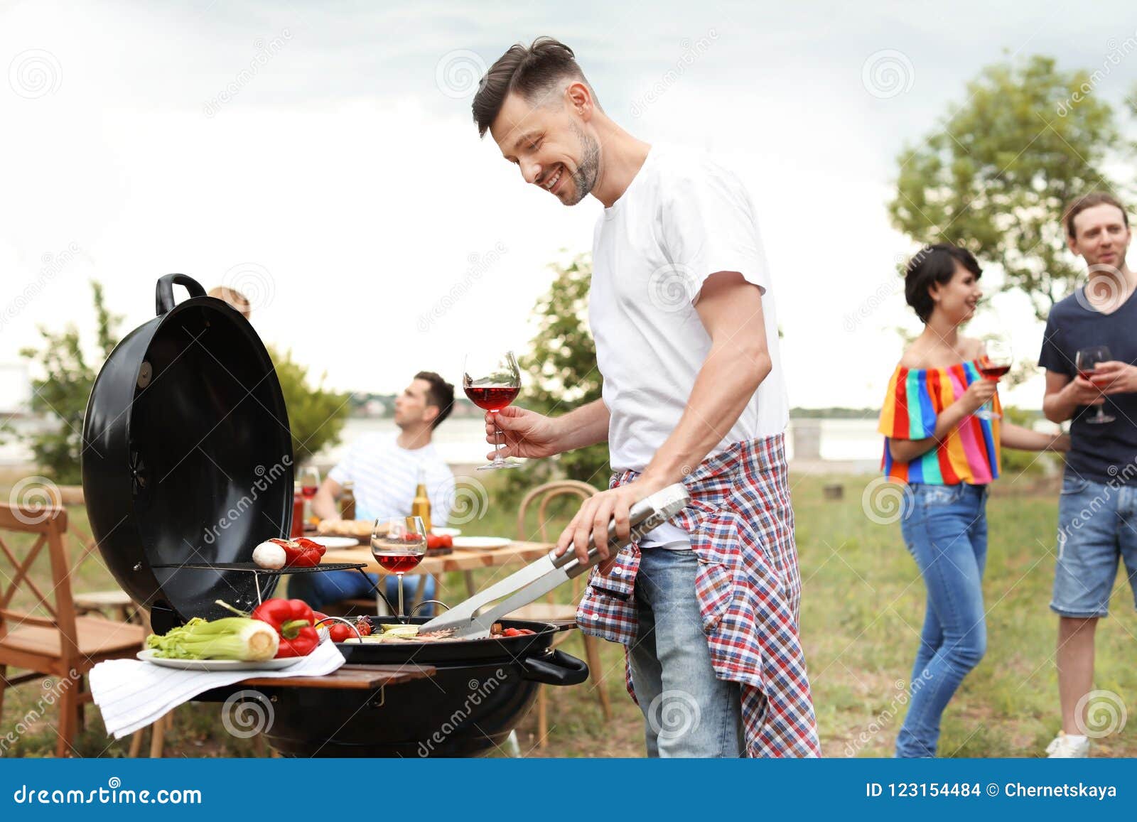 Young People Having Barbecue with Modern Grill Stock Photo - Image of ...