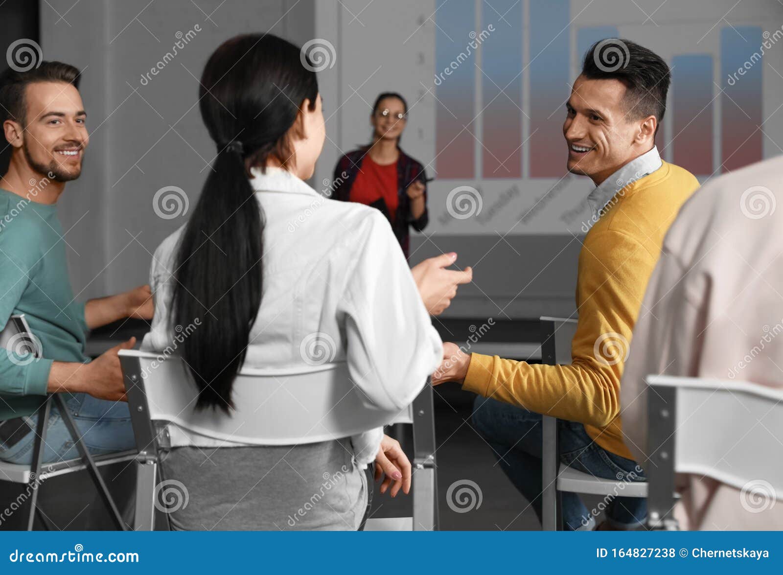 Young People Having Business Training in Room with Projection Screen ...