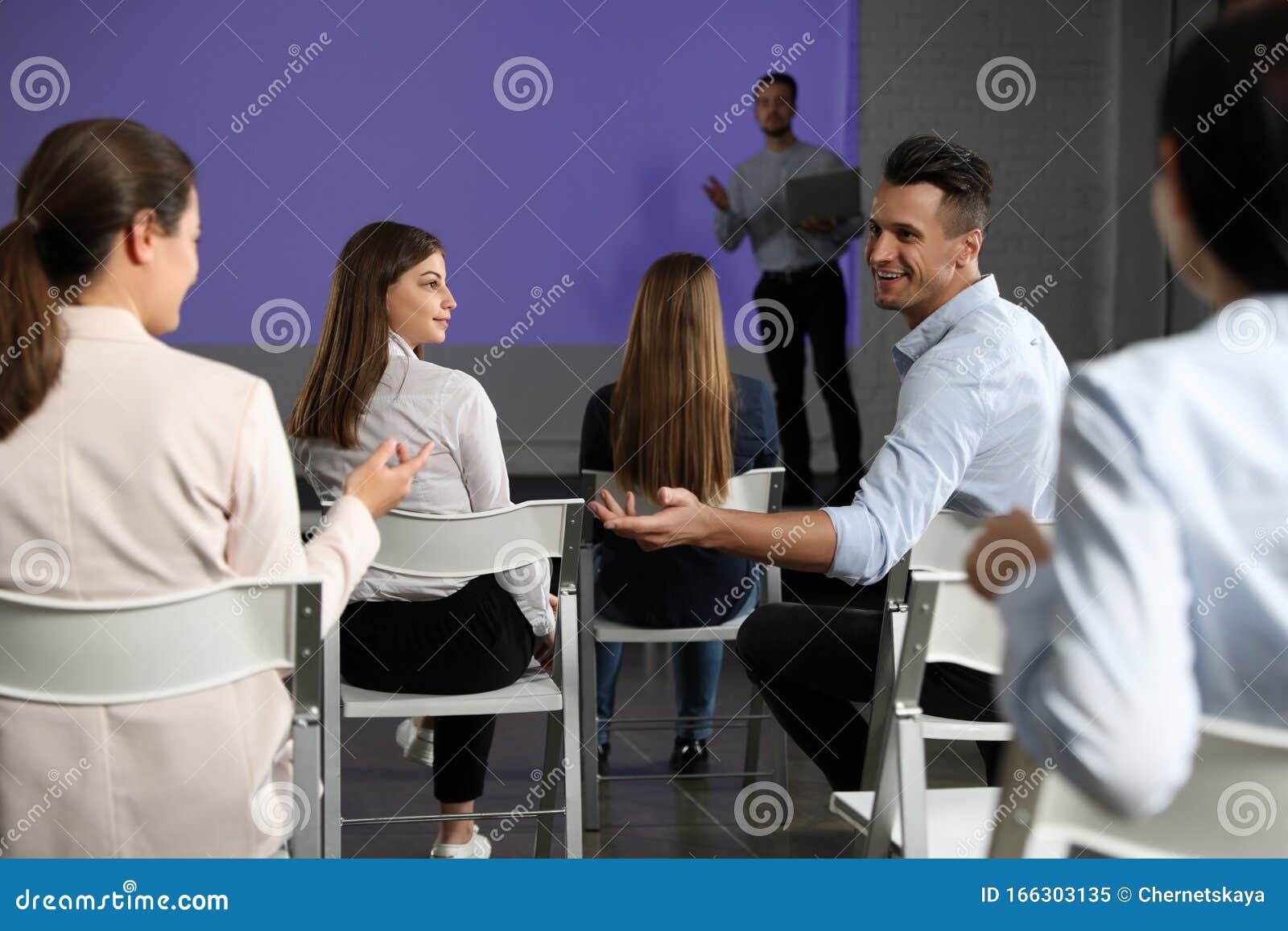 Young People Having Business Training in Room with Projection Screen ...