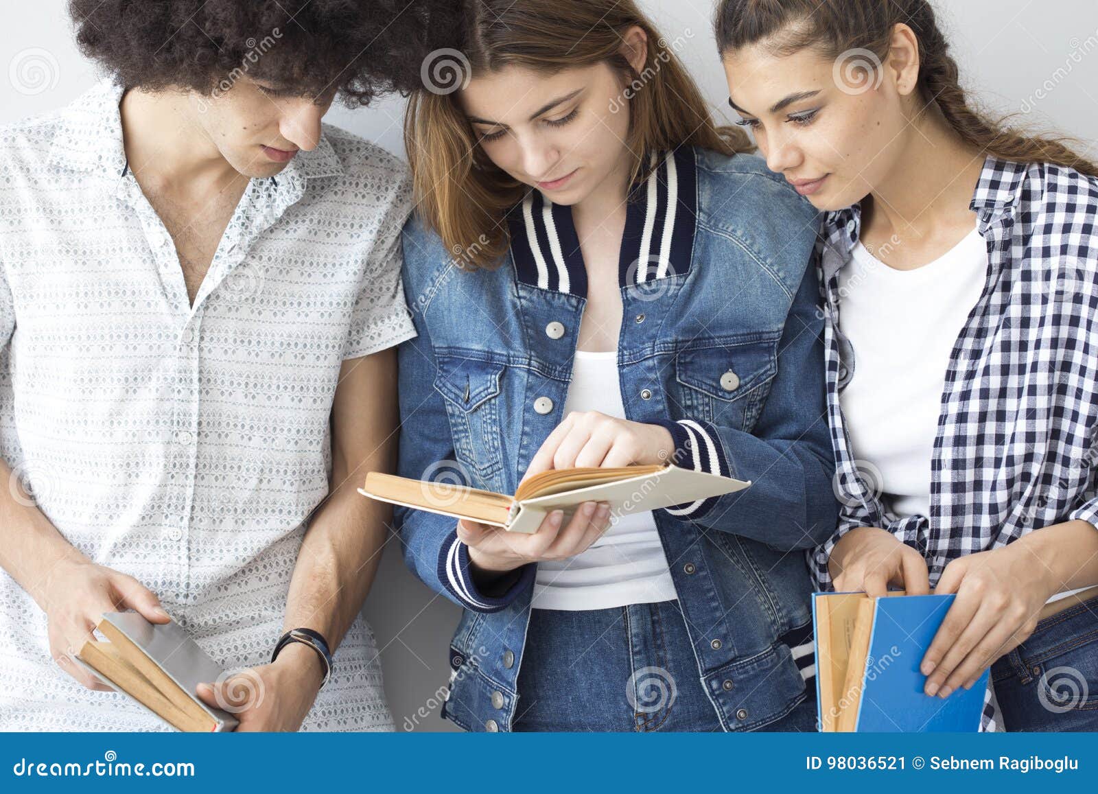 Young People Looking at a Book Stock Image - Image of group, friendship ...