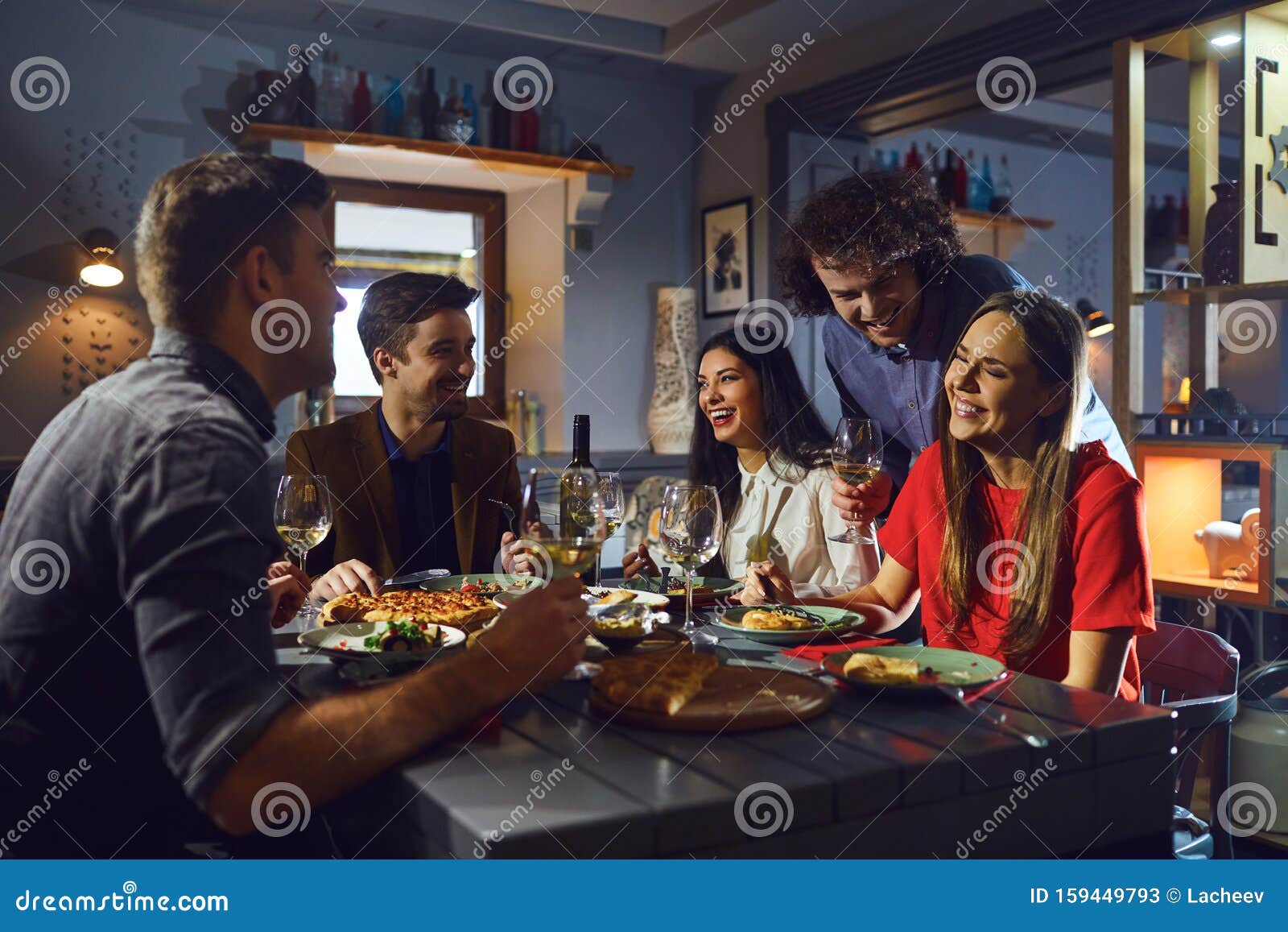 Young People Meeting Friends for Dinner in a Restaurant Stock Image ...
