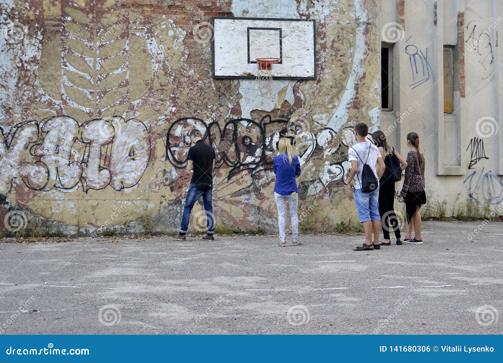 Young People Paint Graffiti on the Wall Editorial Photo - Image of ...