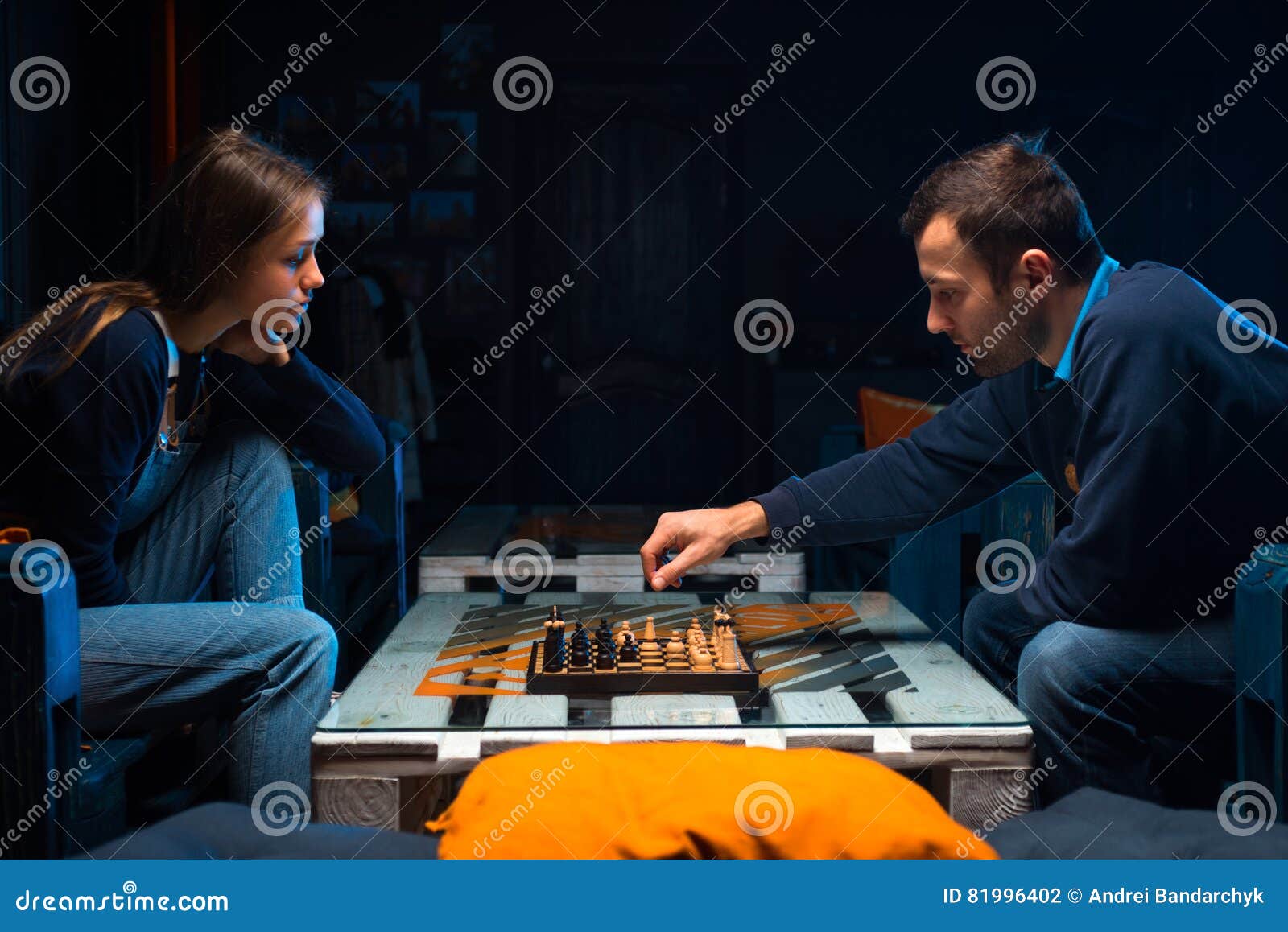 Young people playing chess stock photo. Image of play - 81996402
