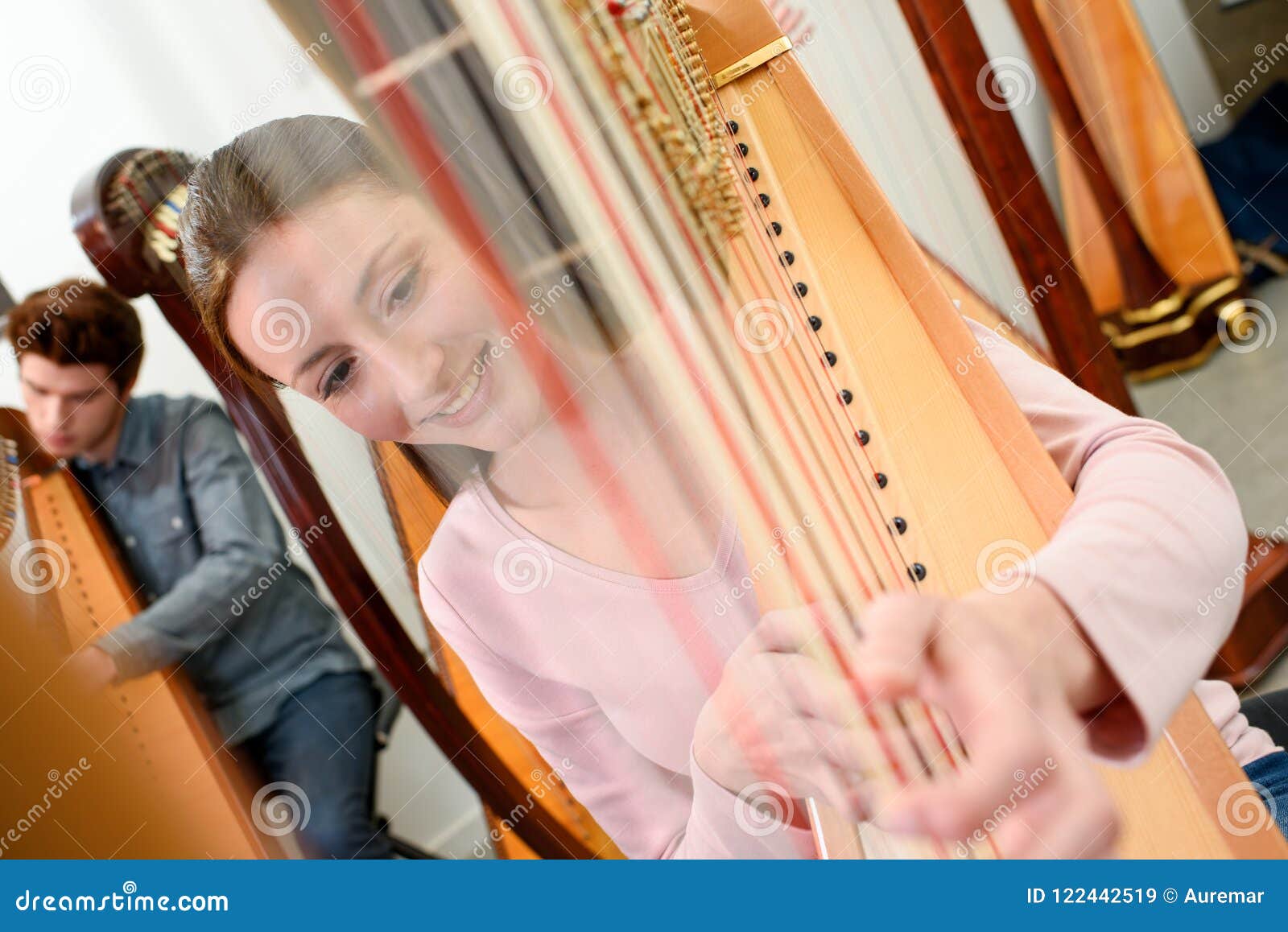Young people playing harps stock image. Image of harp - 122442519