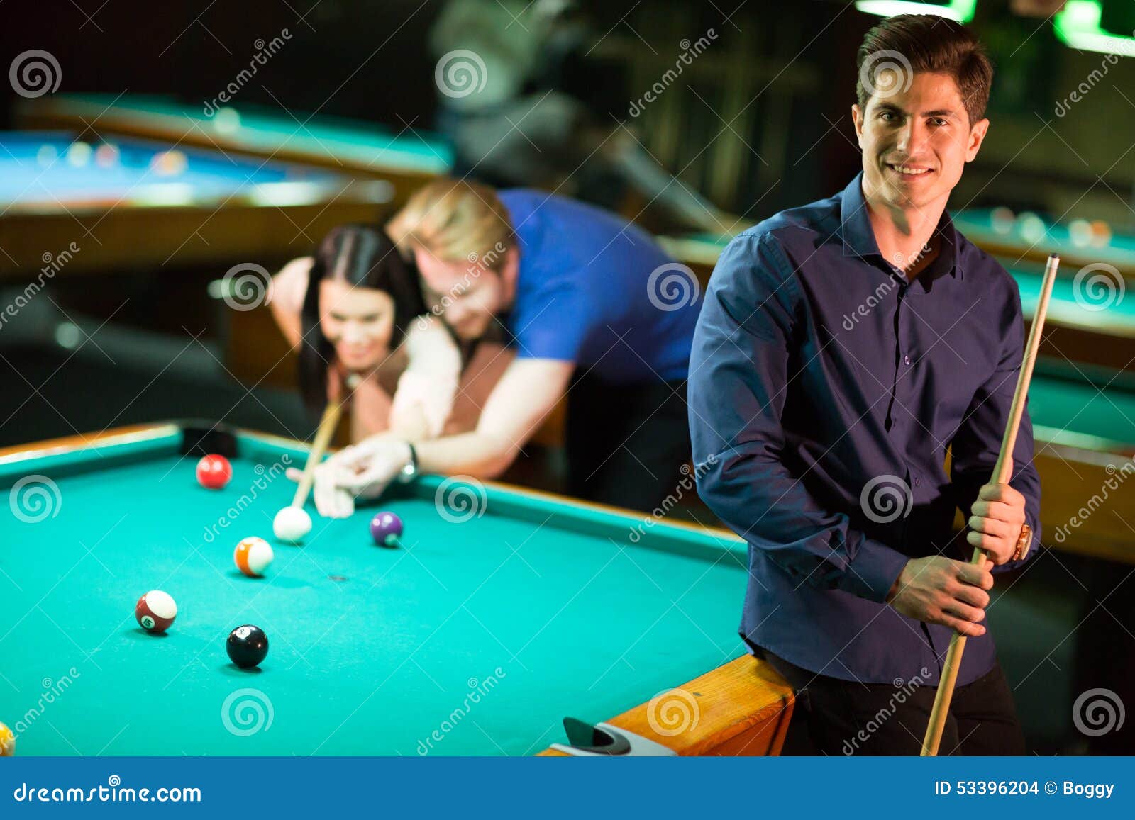 Young people playing pool stock photo. Image of nightlife - 53396204