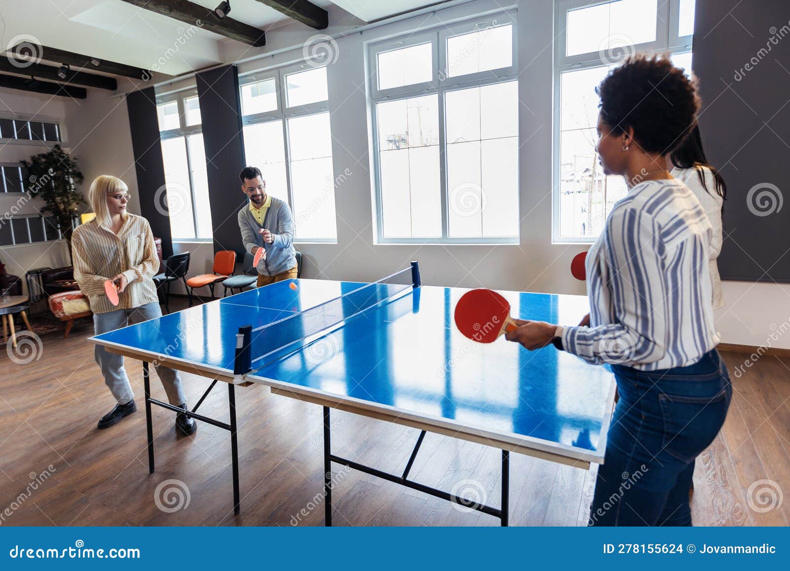 People Playing Table Tennis in the Office at Work Stock Photo - Image ...