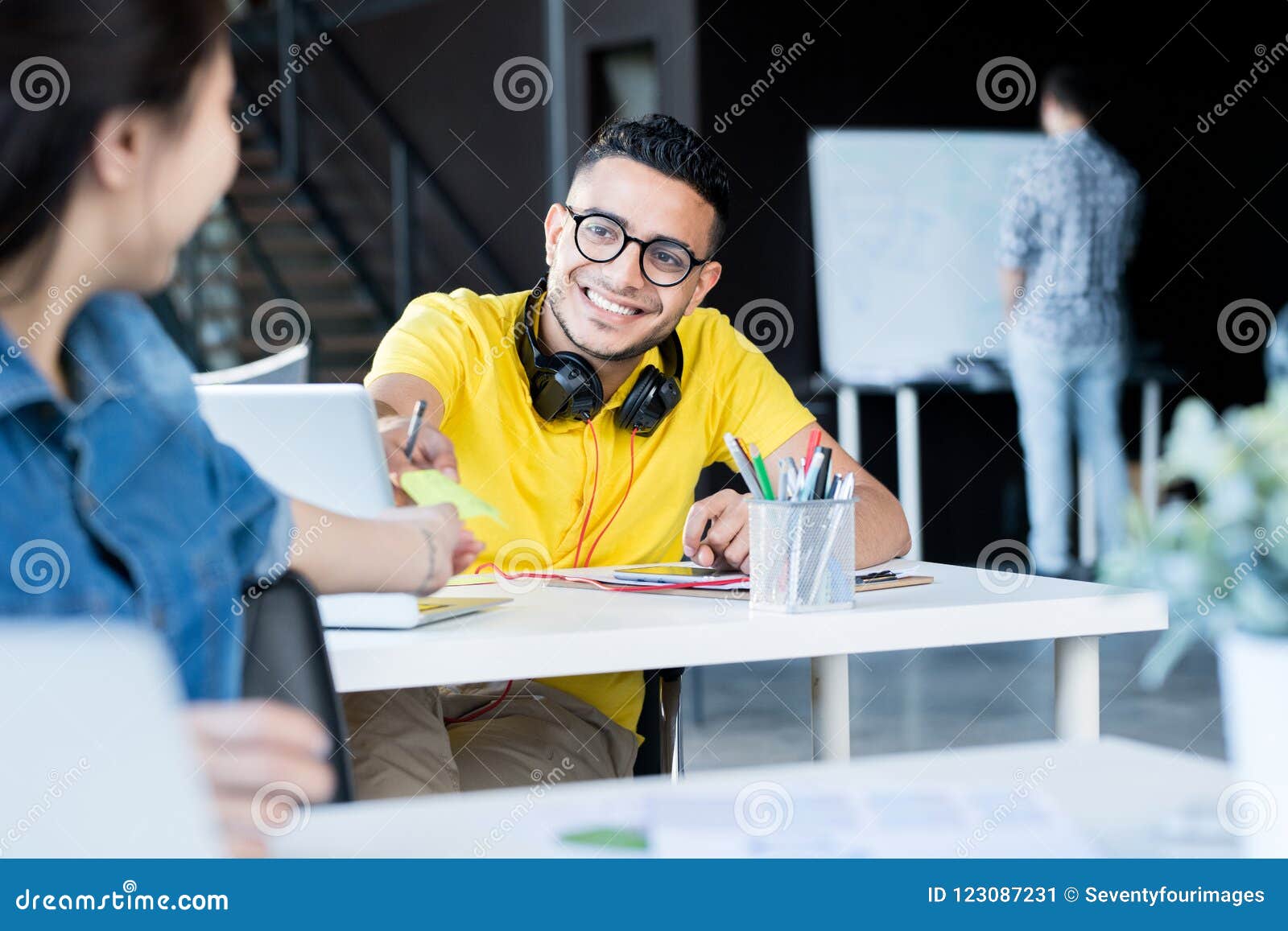 Young People Sharing Notes in Office Stock Image - Image of note, work ...