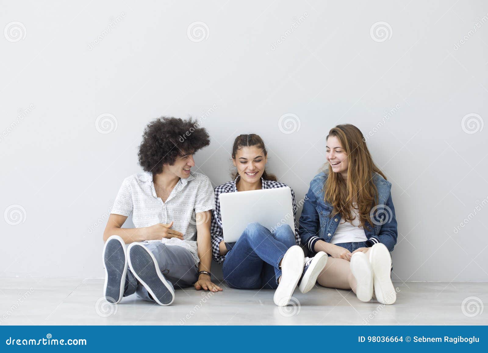 Young People Sitting and Talking with a Computer Stock Photo - Image of ...