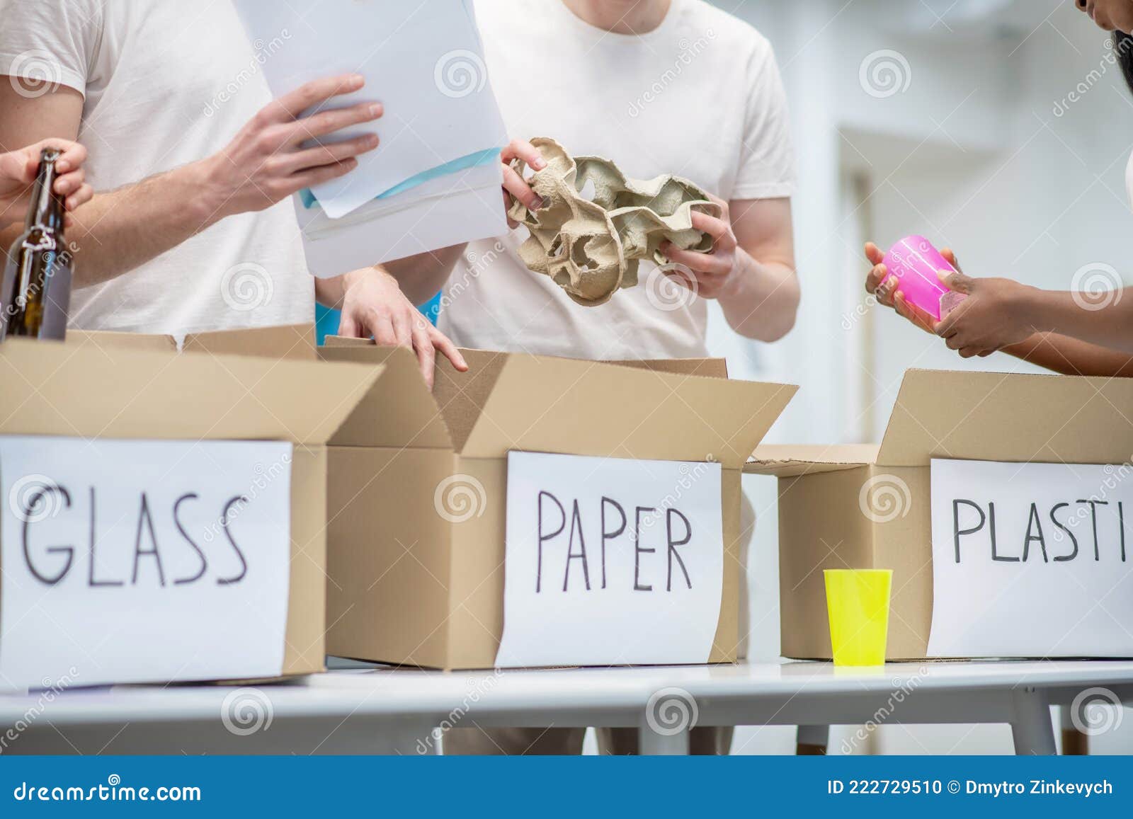 Young People Sorting Trash into Appropriate Boxes Stock Photo - Image ...