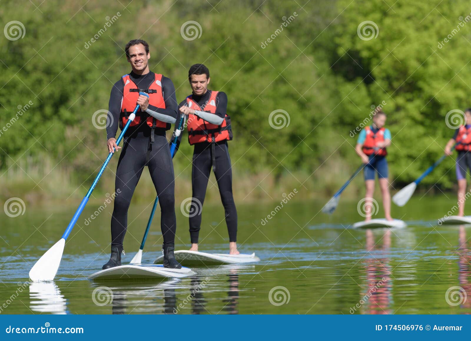 Young People Stood on Paddle Boards Stock Photo - Image of smile ...
