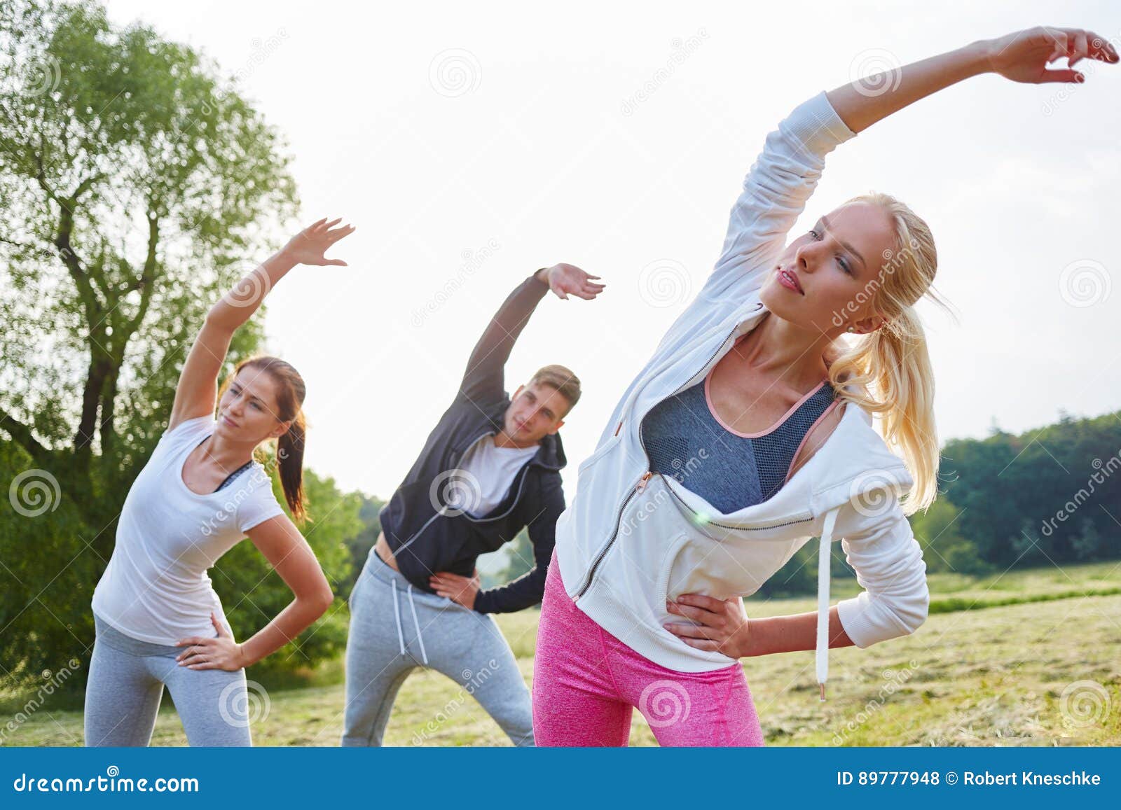 Young people stretching stock photo. Image of athlete - 89777948