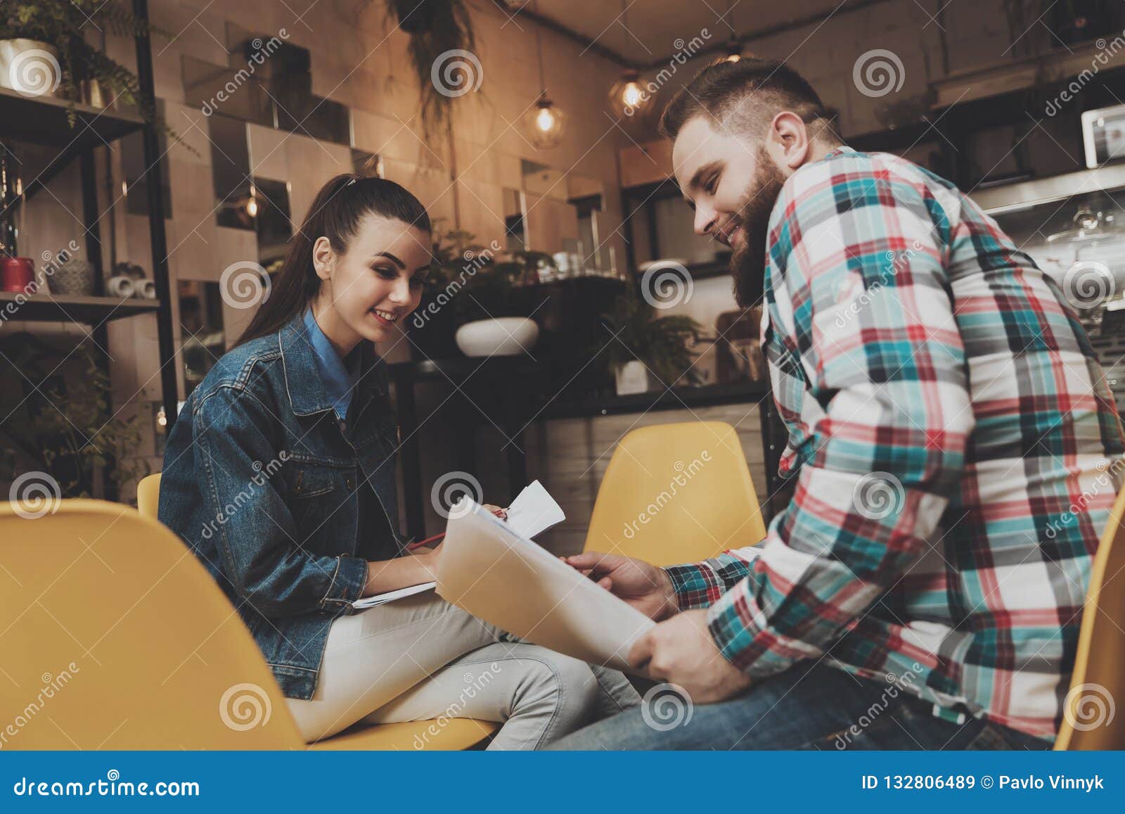 Young People Studying Documents while in a Cafe Stock Image - Image of ...