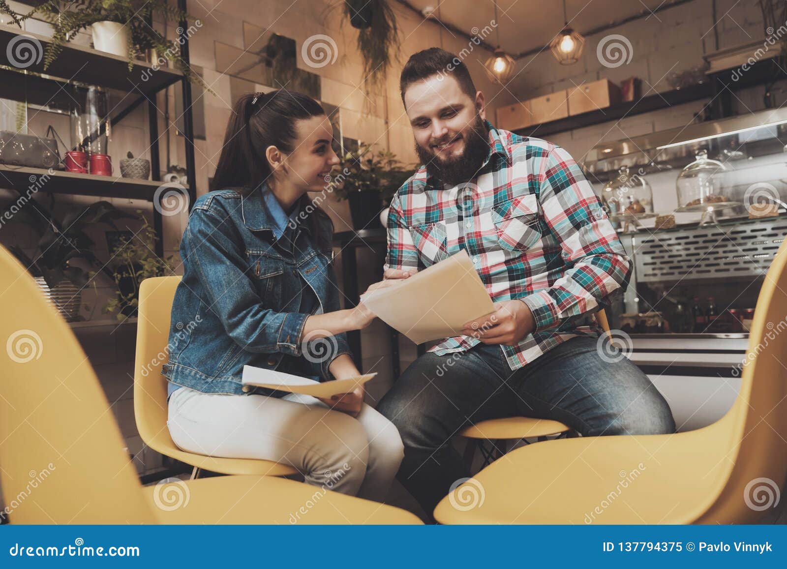 Young People Studying Documents while in a Cafe Stock Image - Image of ...