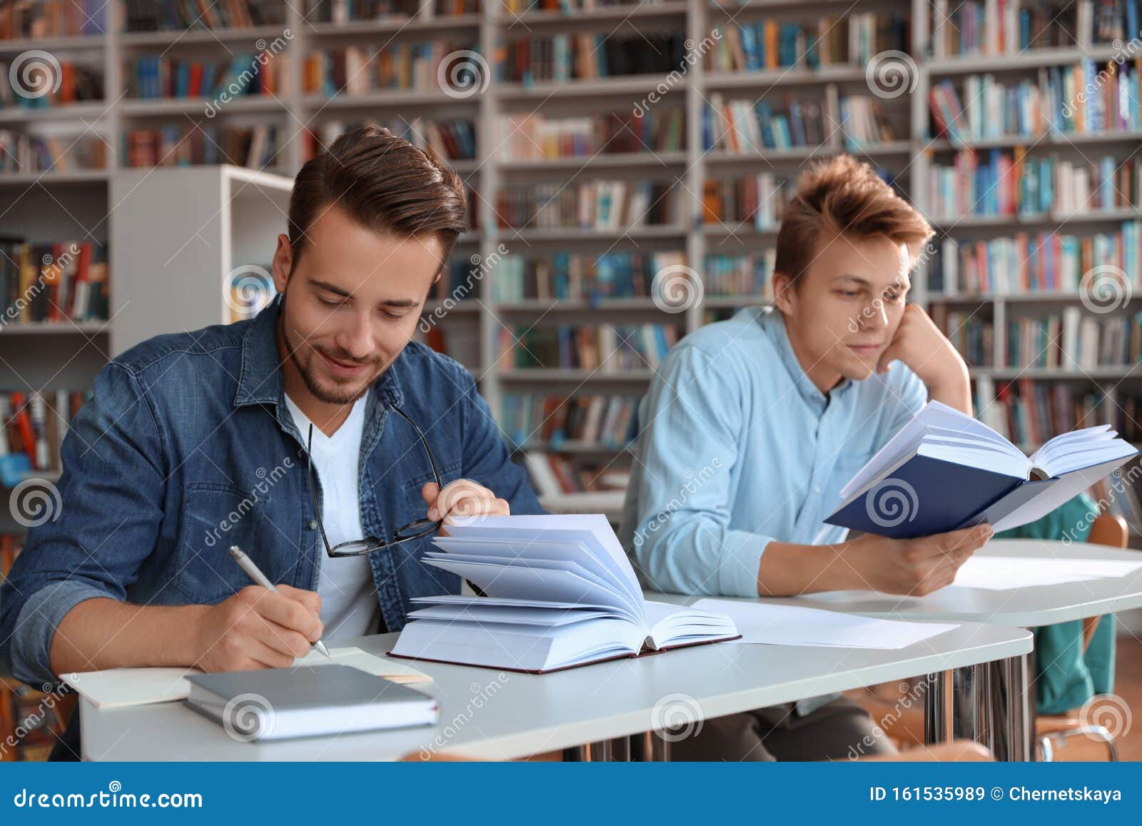 Young People Studying at Table Stock Image - Image of happy, reading ...