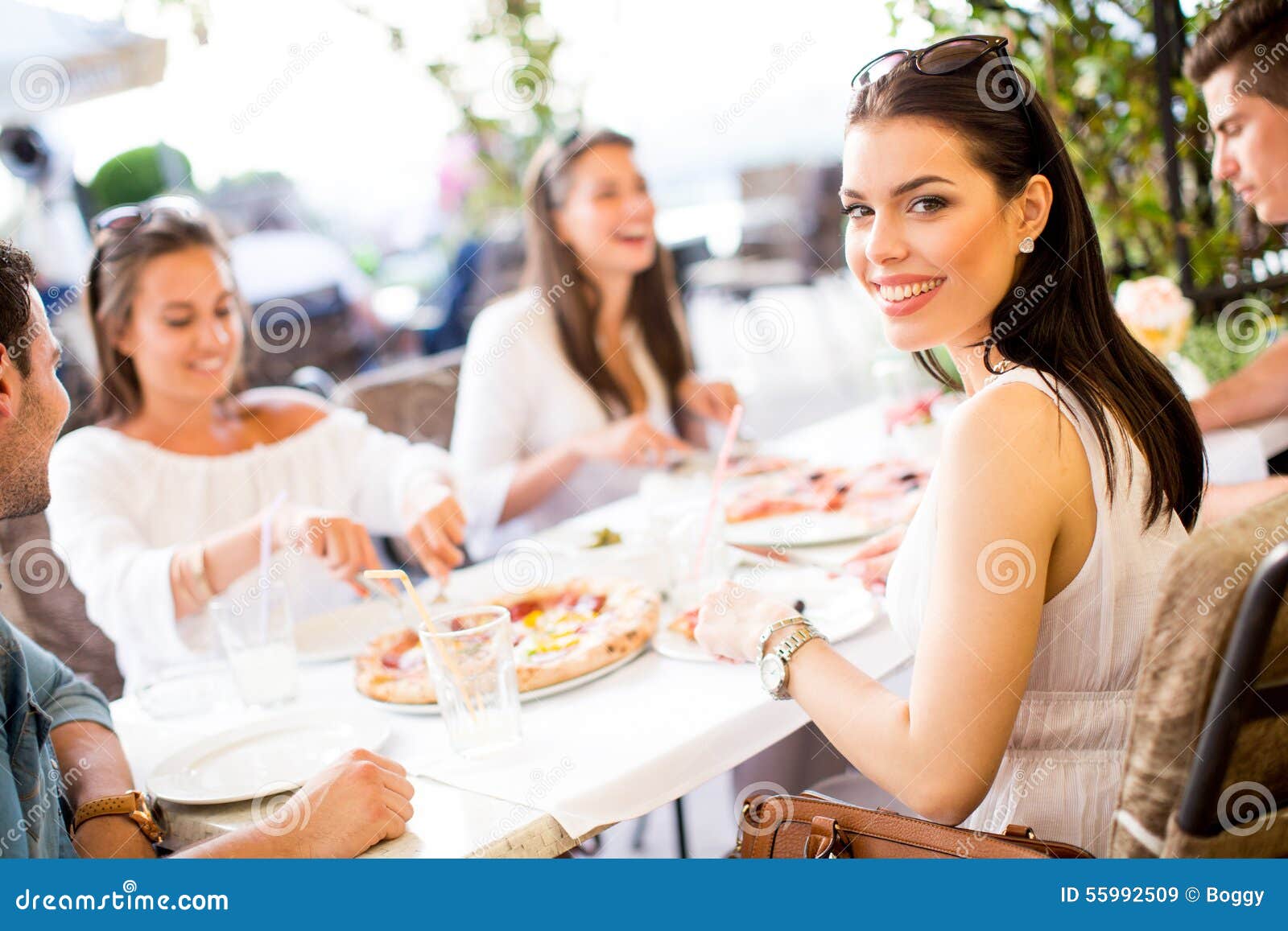 Young people by the table stock image. Image of women - 55992509