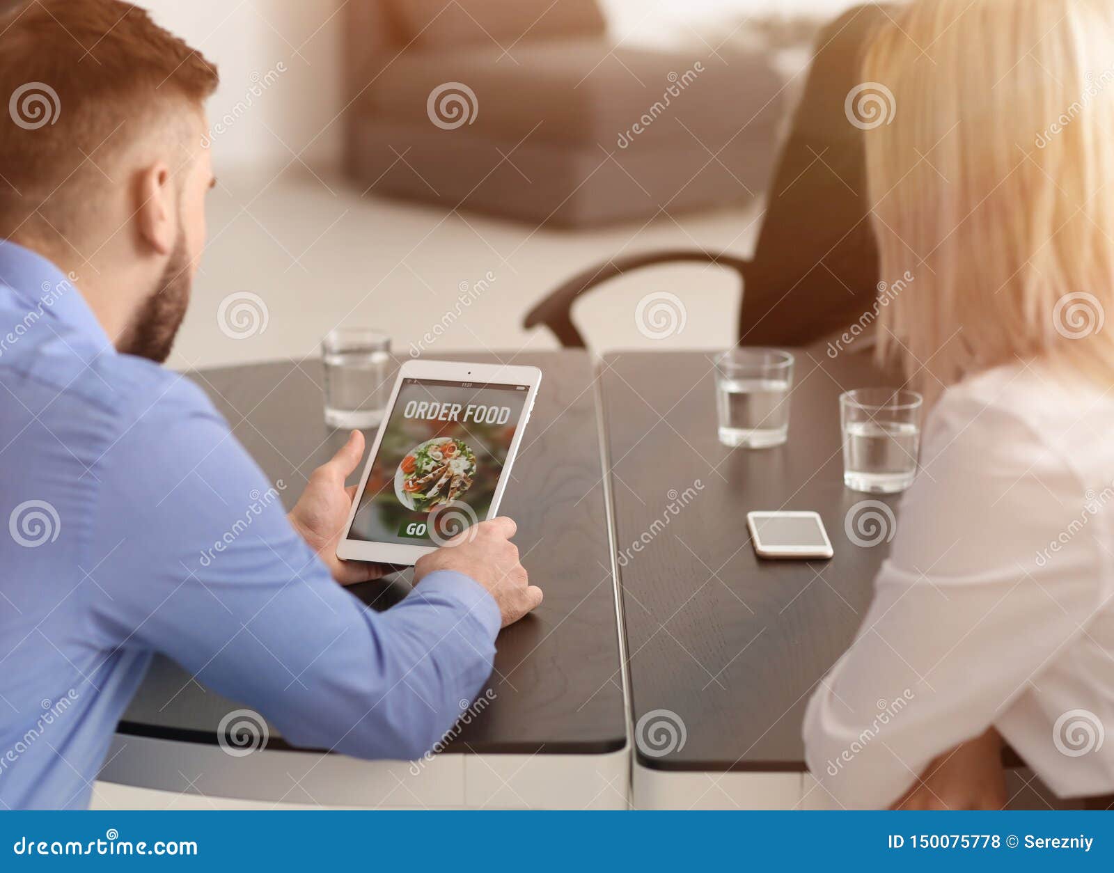 Young People Using Tablet Computer for Ordering Food in Office Stock ...