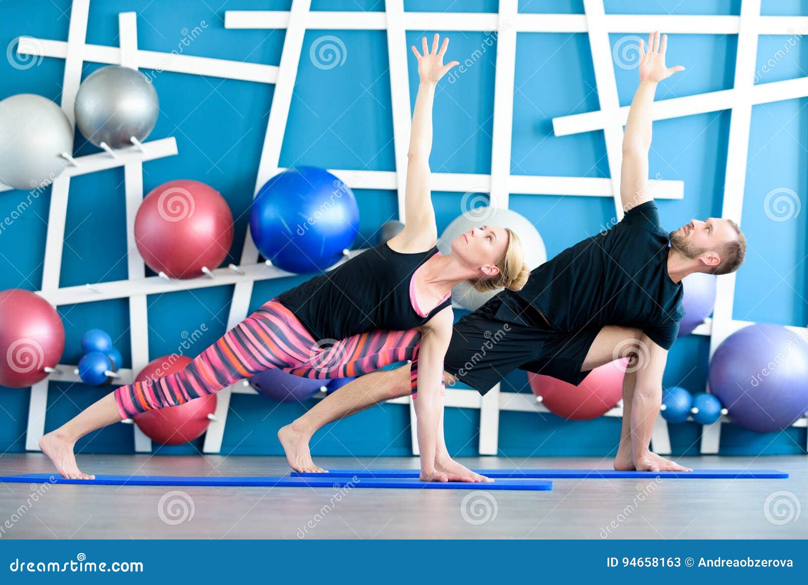 Young People in Yoga Class in Extended Side Angle Pose. Yoga Group ...