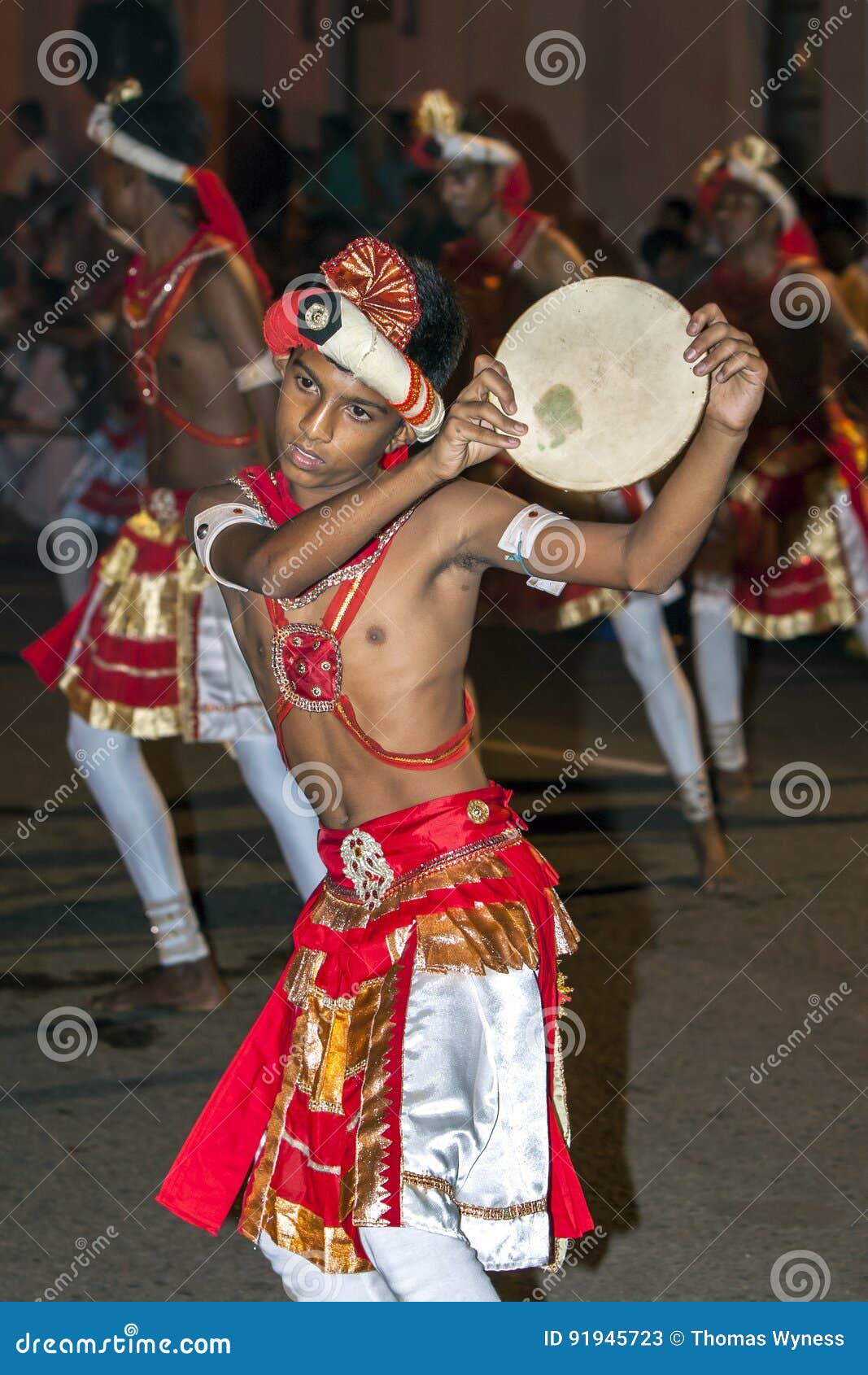 A Young Performer Dances Along a Street in Kandy during the Esala ...