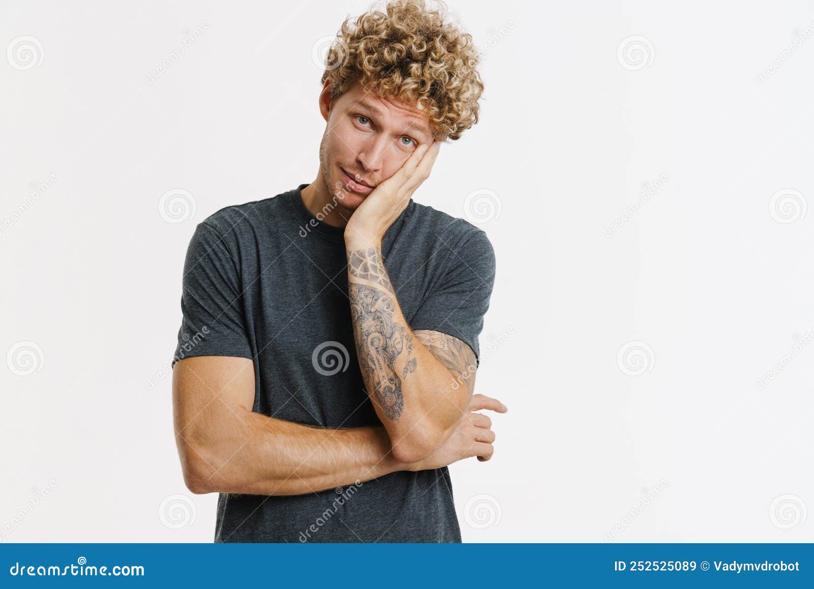 Young Perplexed Man Looking at Camera while Propping Up His Head Stock ...