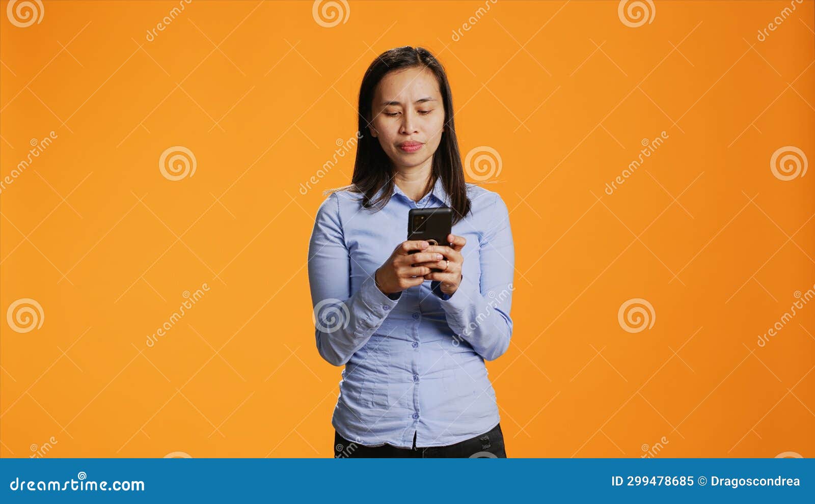 Young Person Texting Messages on Mobile Device in Studio Stock Image ...