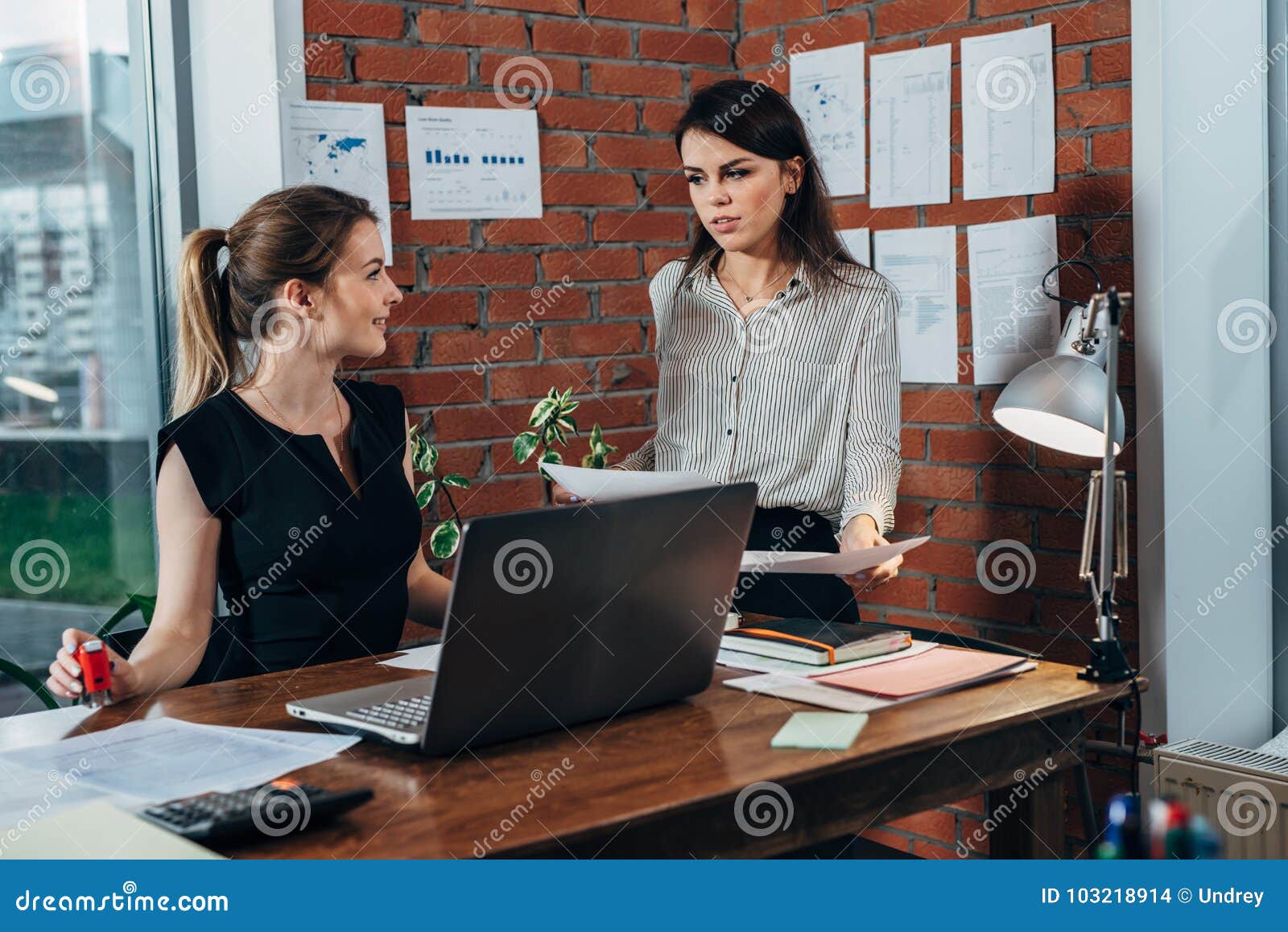 Young Personal Assistant Discussing Plans with Boss in Her Office Stock ...