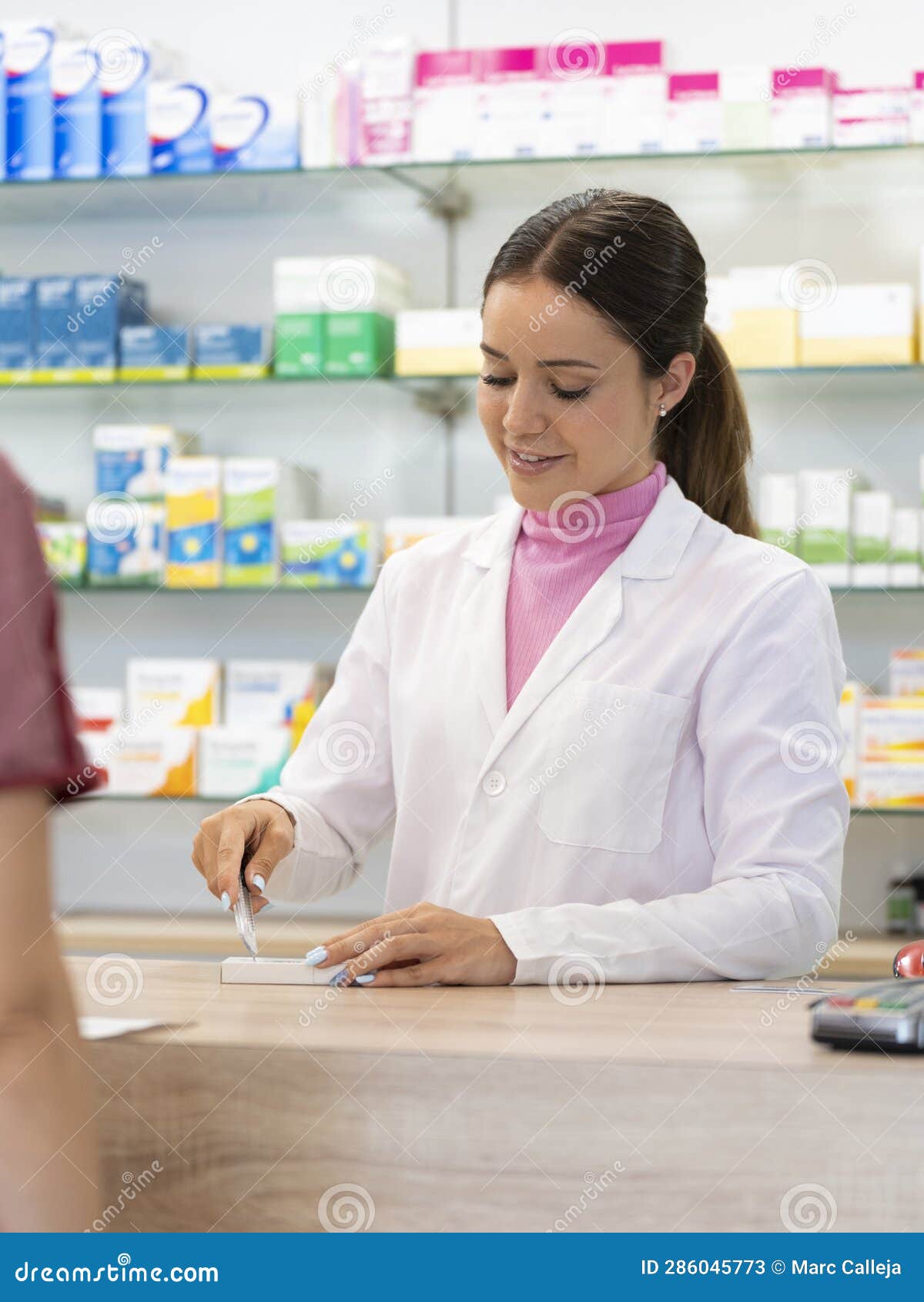 A Young Pharmacist Cutting the Barcode of a Prescribed Medication Stock ...