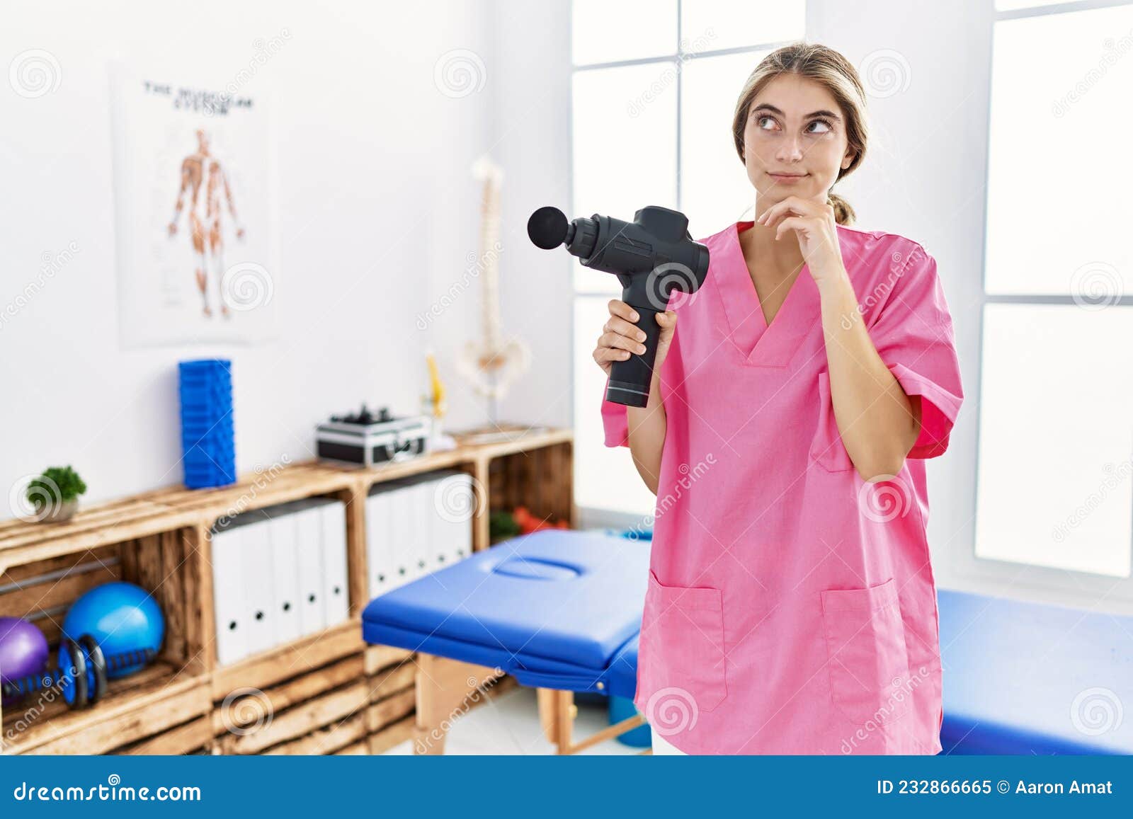 Young Physiotherapist Woman Holding Therapy Massage Gun At Wellness