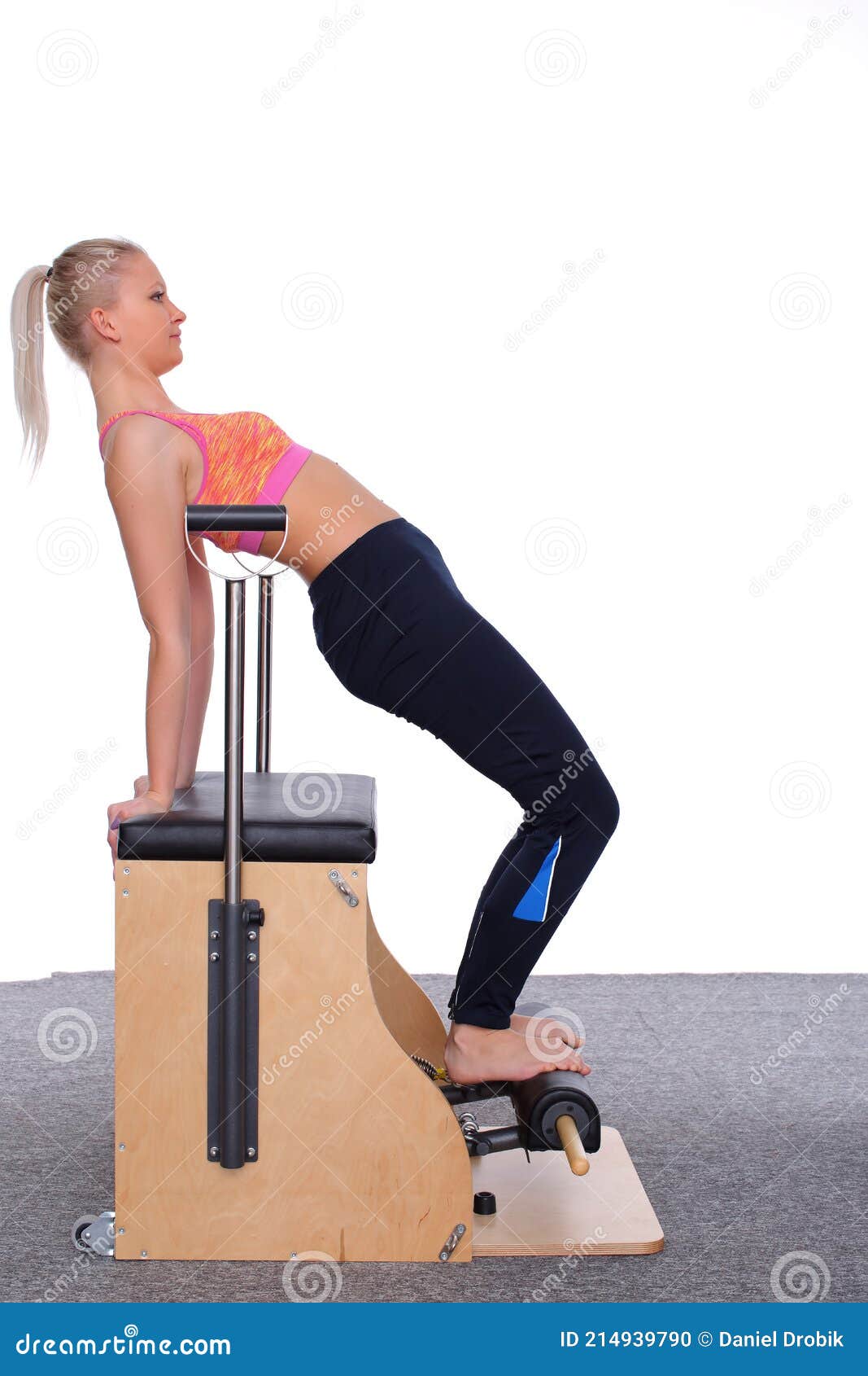 A 20-year-old Trainer Practices Pilates on an Elevator Chair, Bending ...