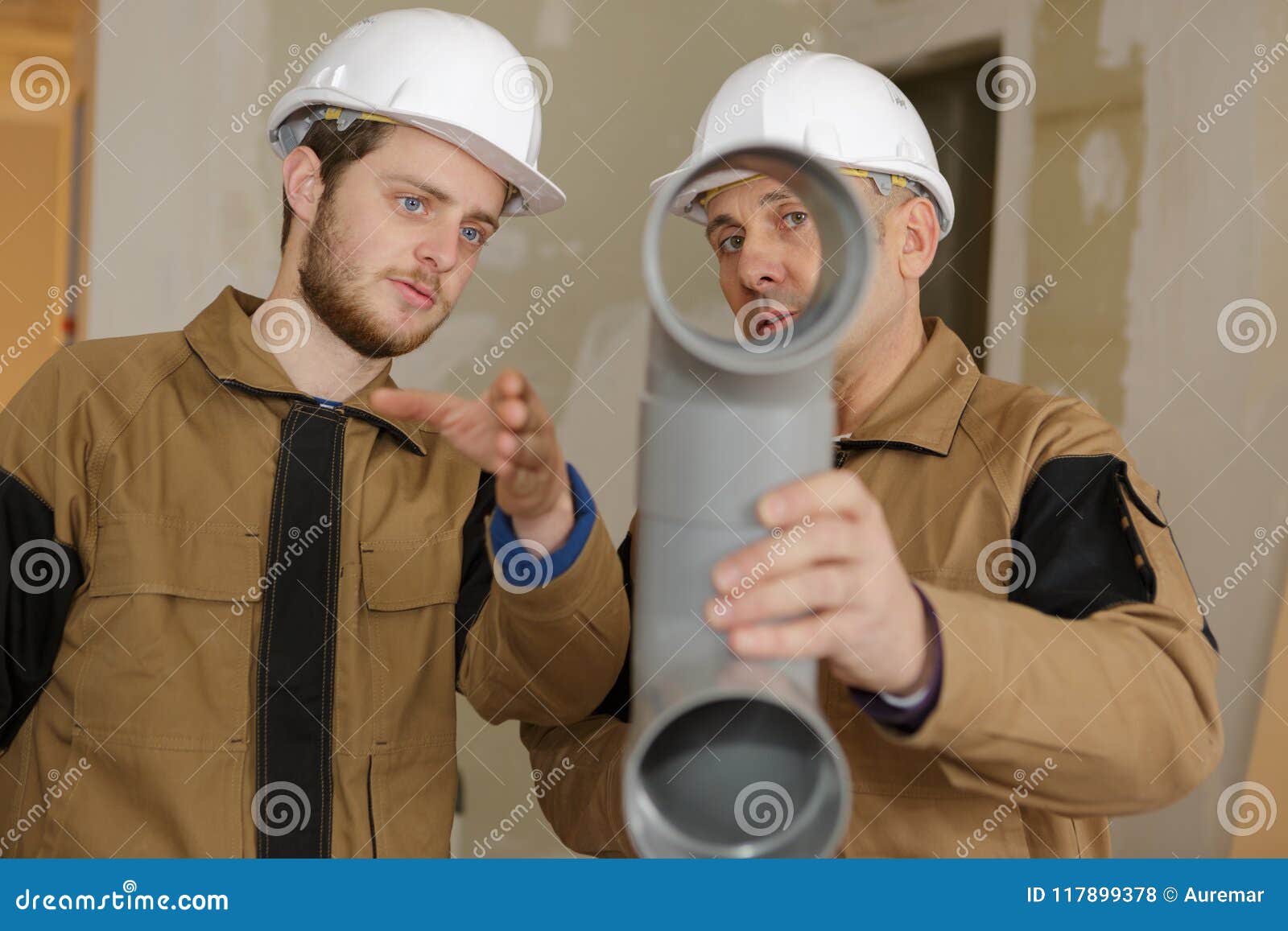 Young Plumber Learning about Pipes Stock Photo - Image of background ...